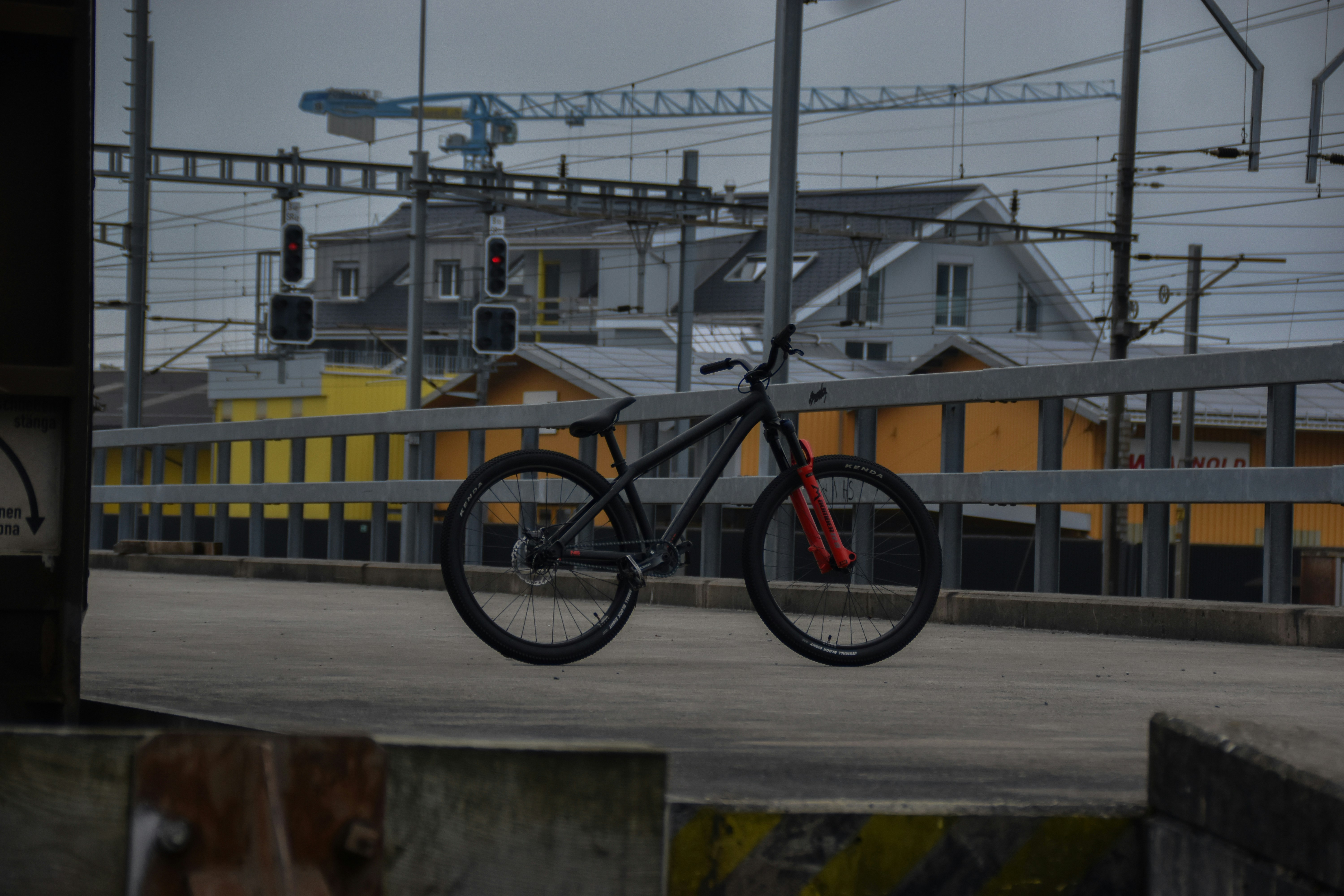 A bicycle is hanging upside down on a rail photo – Free Light Image on ...