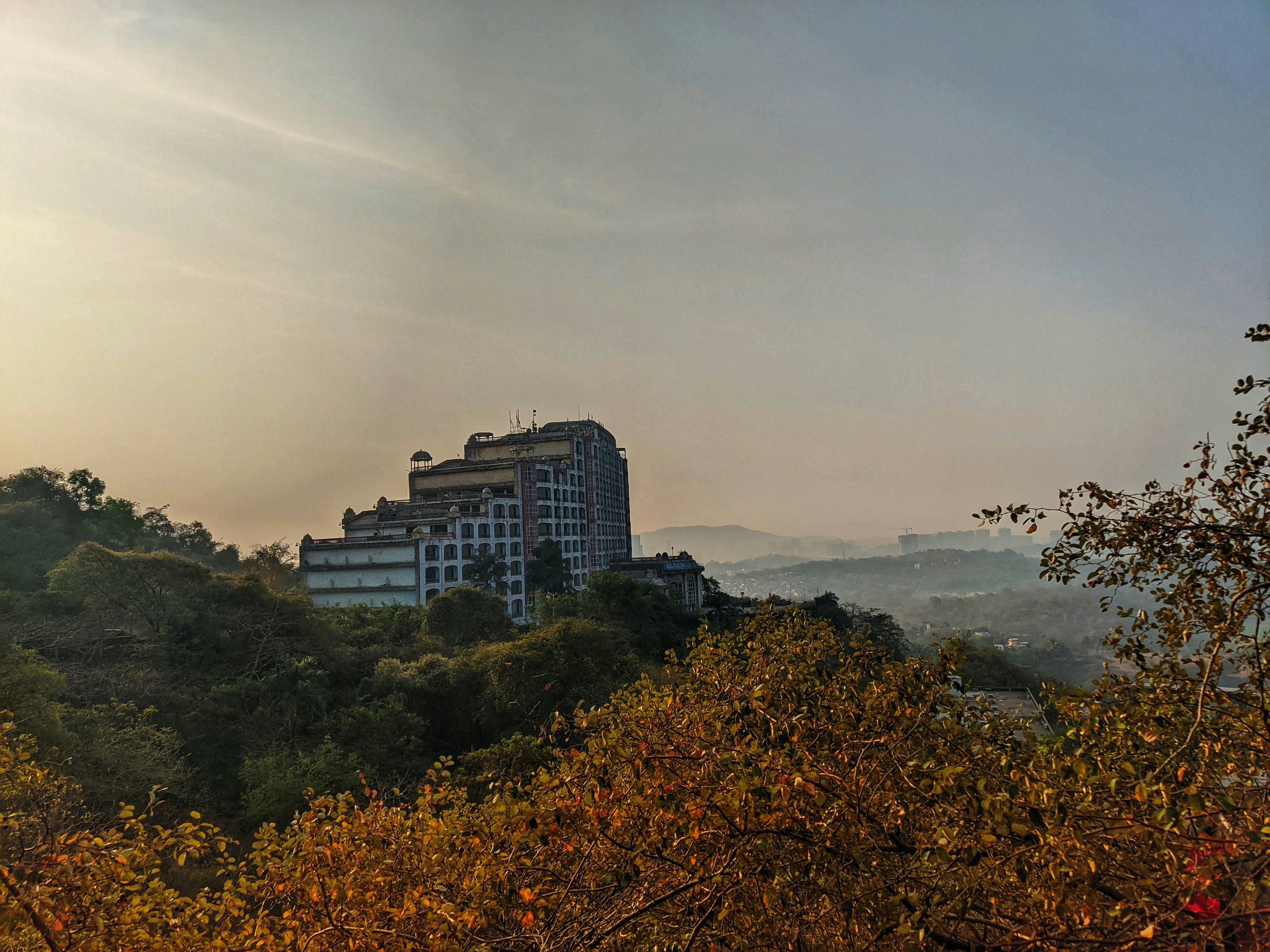 Hilled Ascent: Golden Hour Overlook with a Modern Campus on the Hill