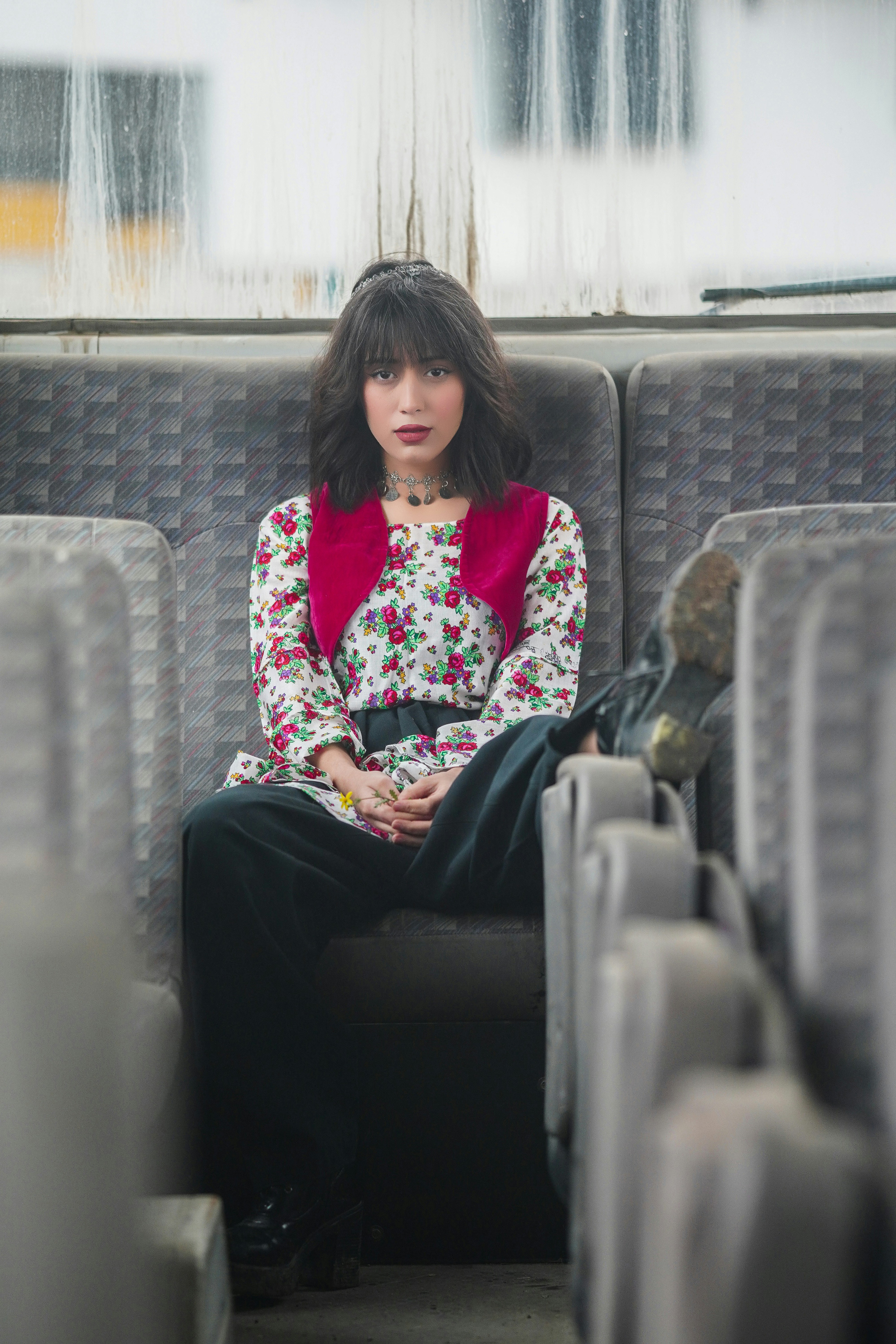 A woman sitting on a bus with her legs crossed photo – Free Woman Image ...