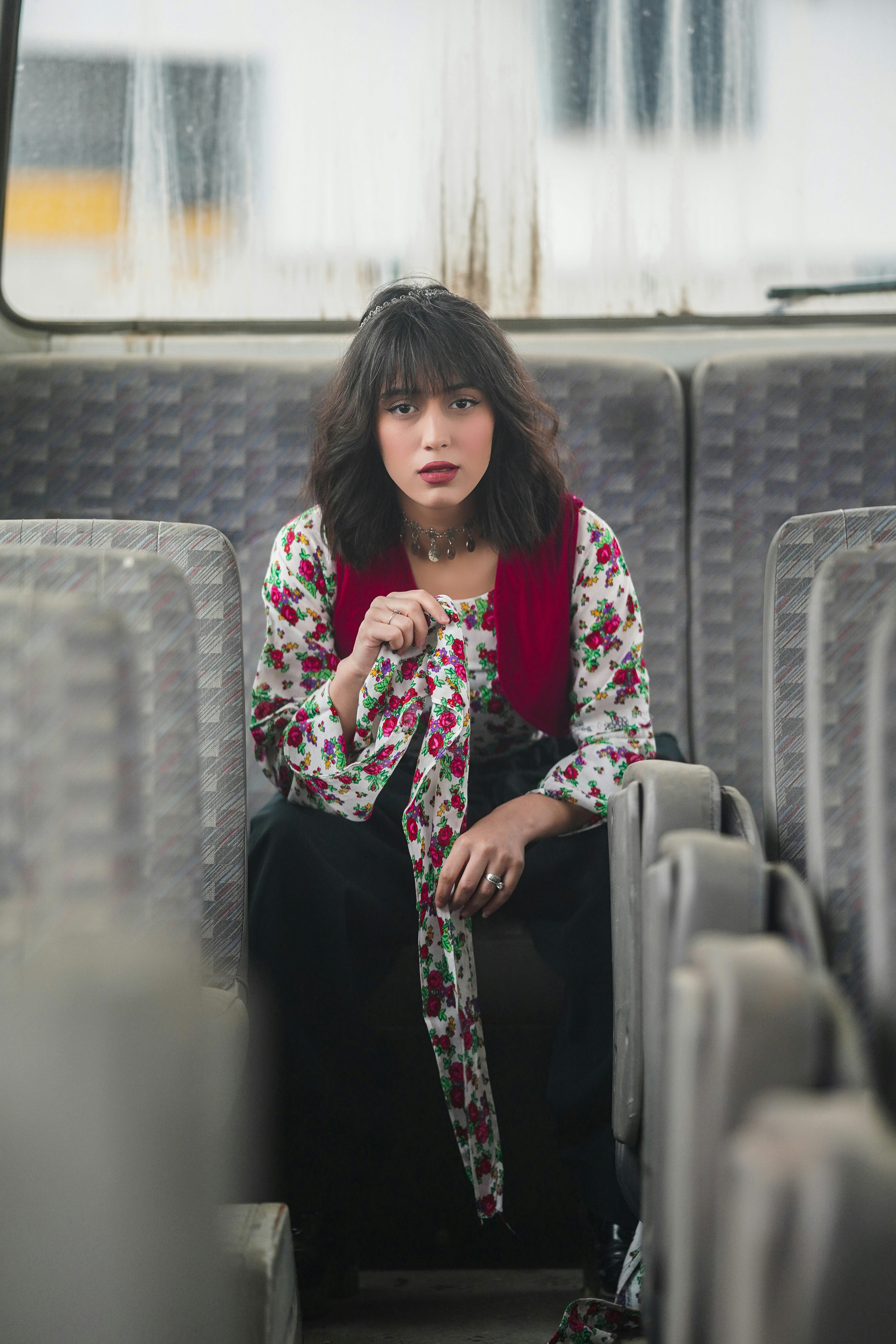 Flowered sleeves and velvet red: a portrait in transit