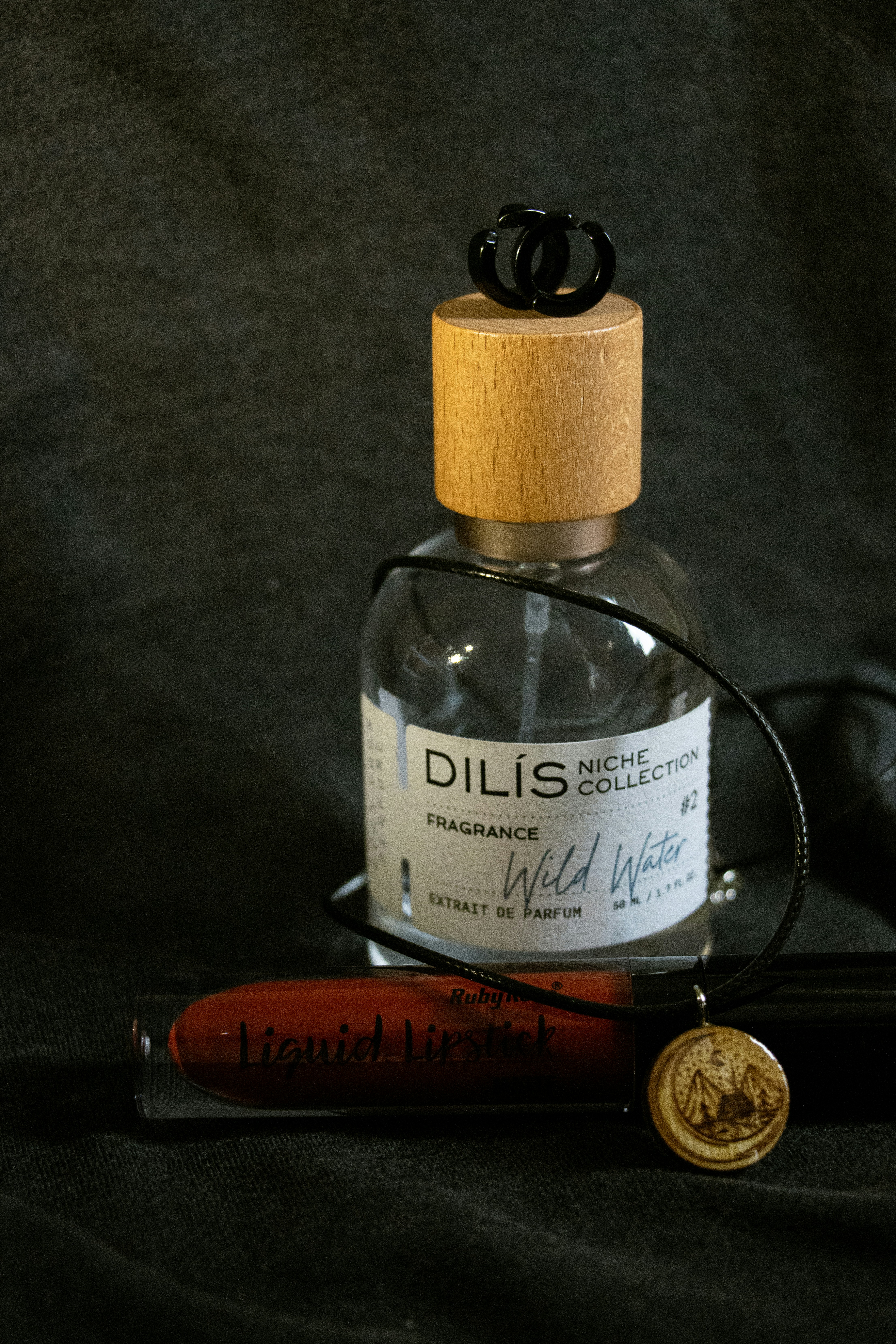 Wooden Cap, Velvet Shadows: A Quiet Still Life of Perfume Bottle and Lipstick