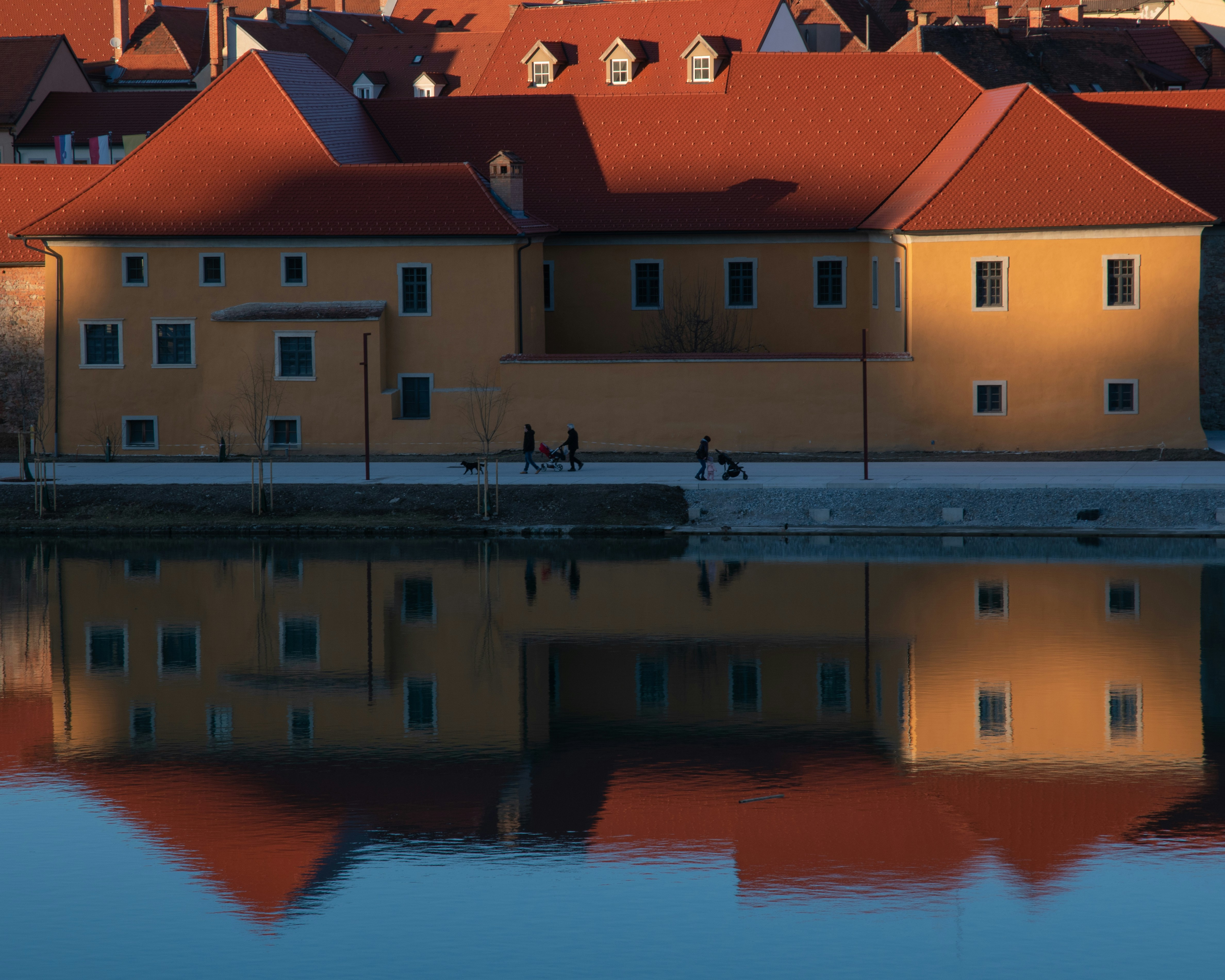 A body of water with houses in the background photo – Free Maribor ...
