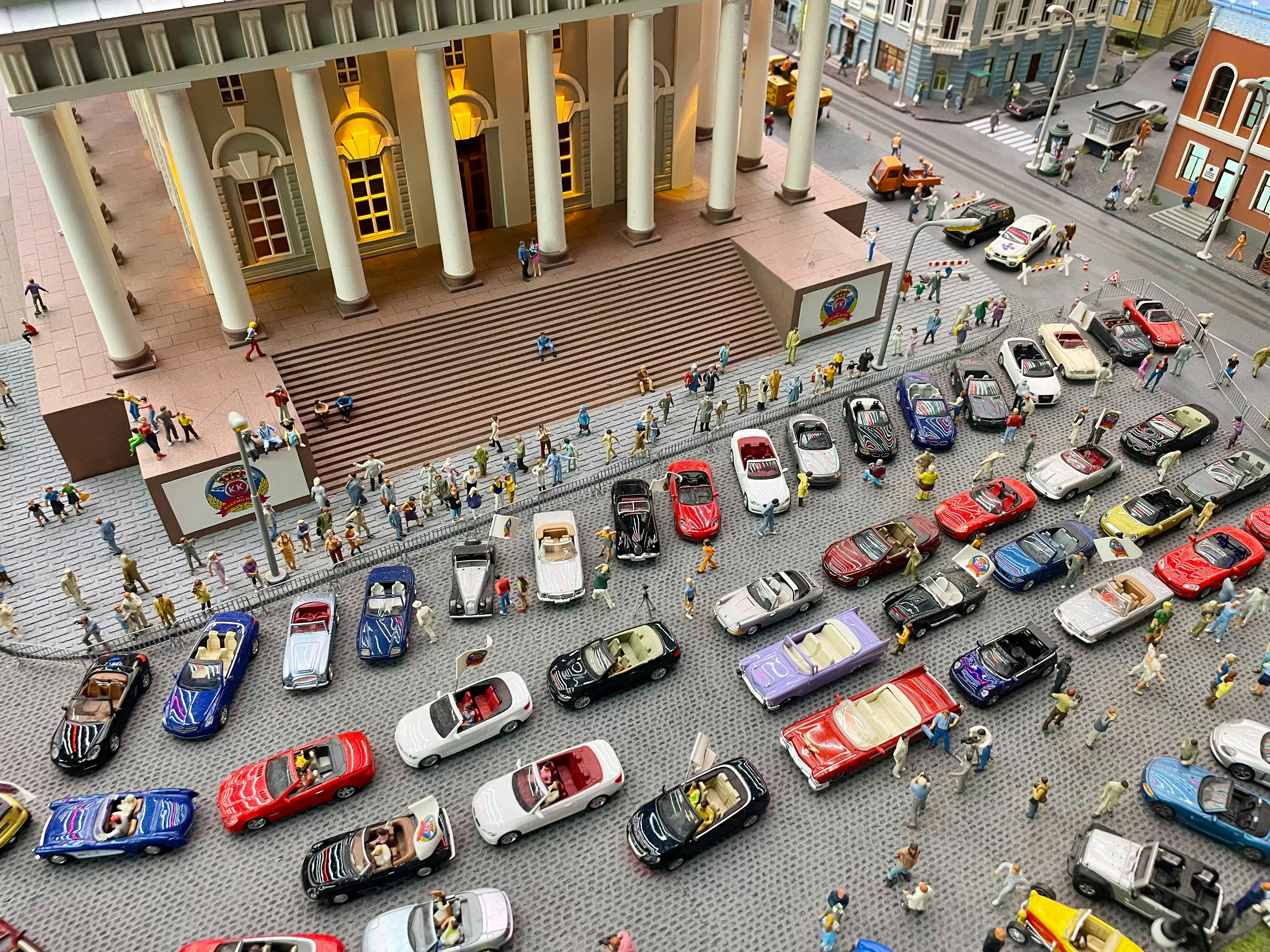 A city street filled with lots of traffic next to tall buildings photo ...