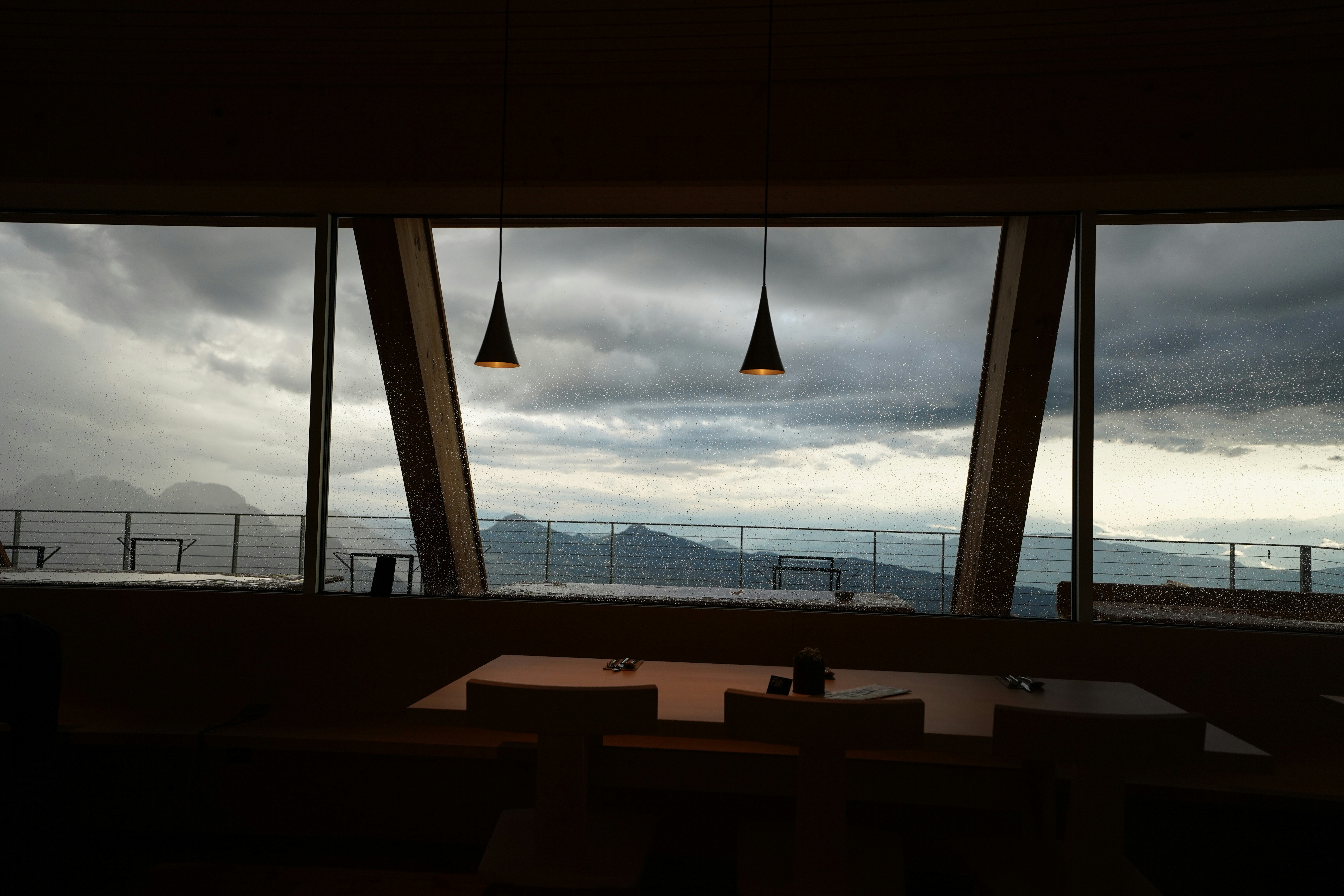 Horizon Framed by Dim Interior: Distant Isles Through a Windowed Café