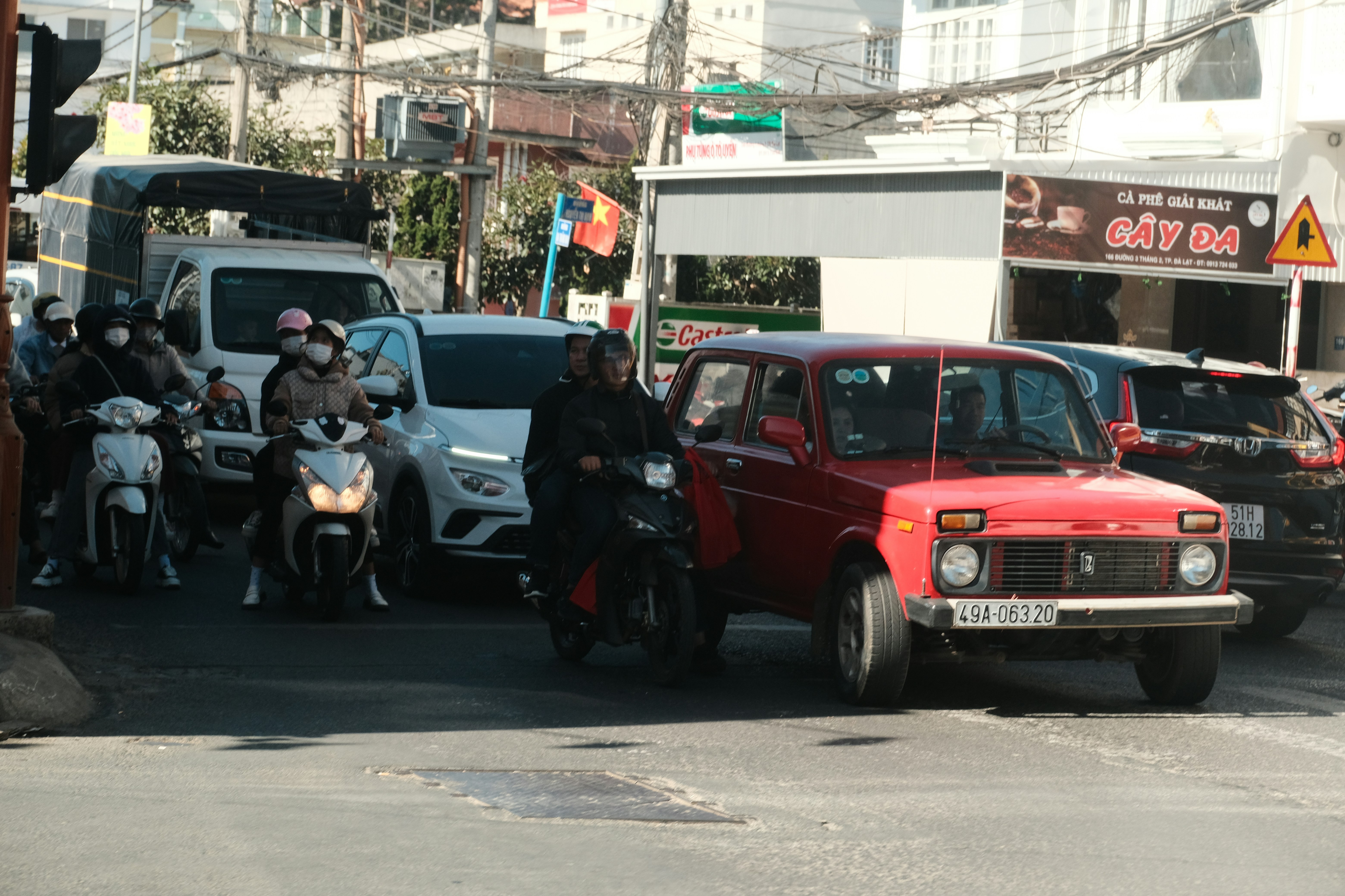 a group of motorcyclists riding down a busy street