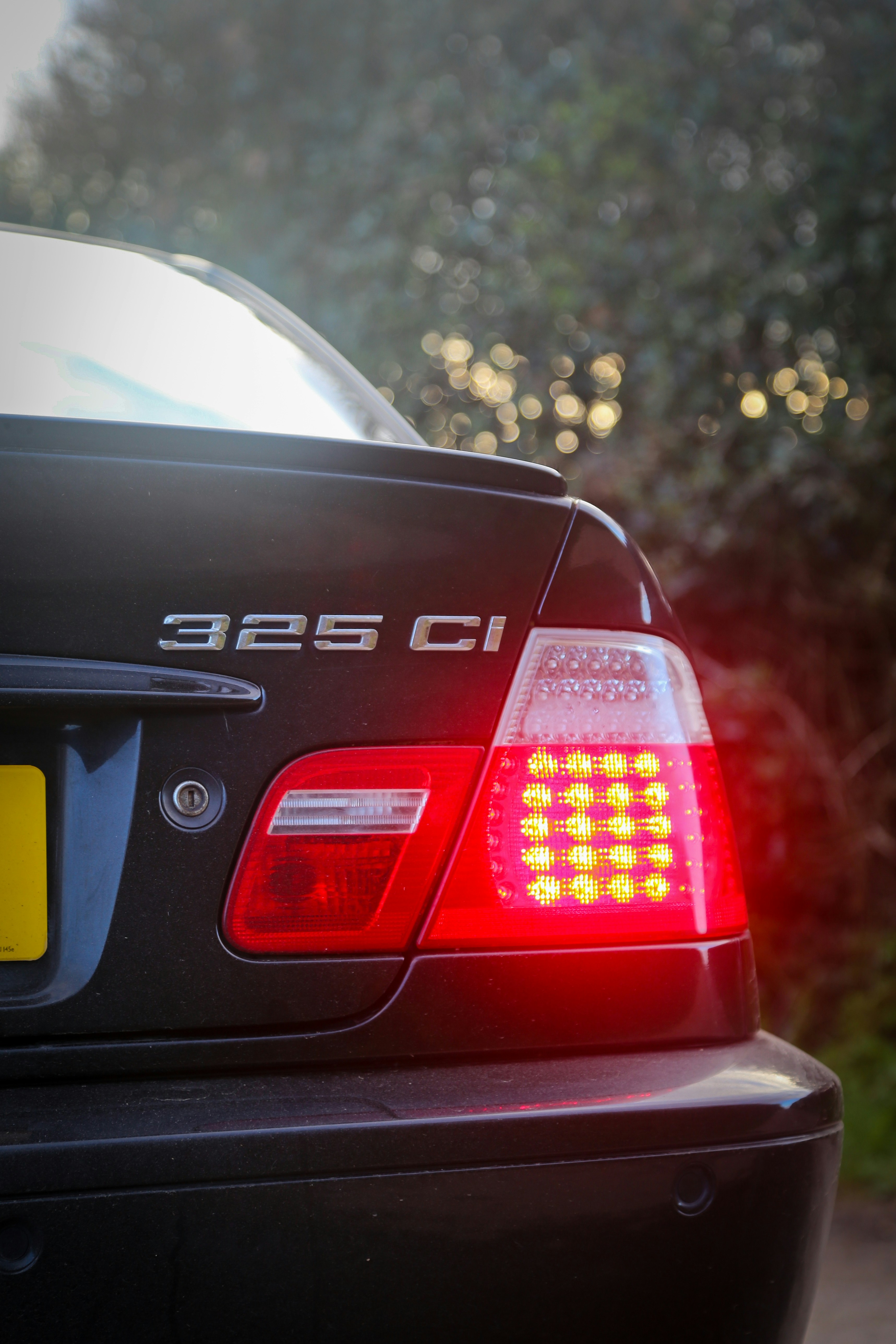 Rear Badge in Focus: A Classic BMW 325 Ci at Dusk