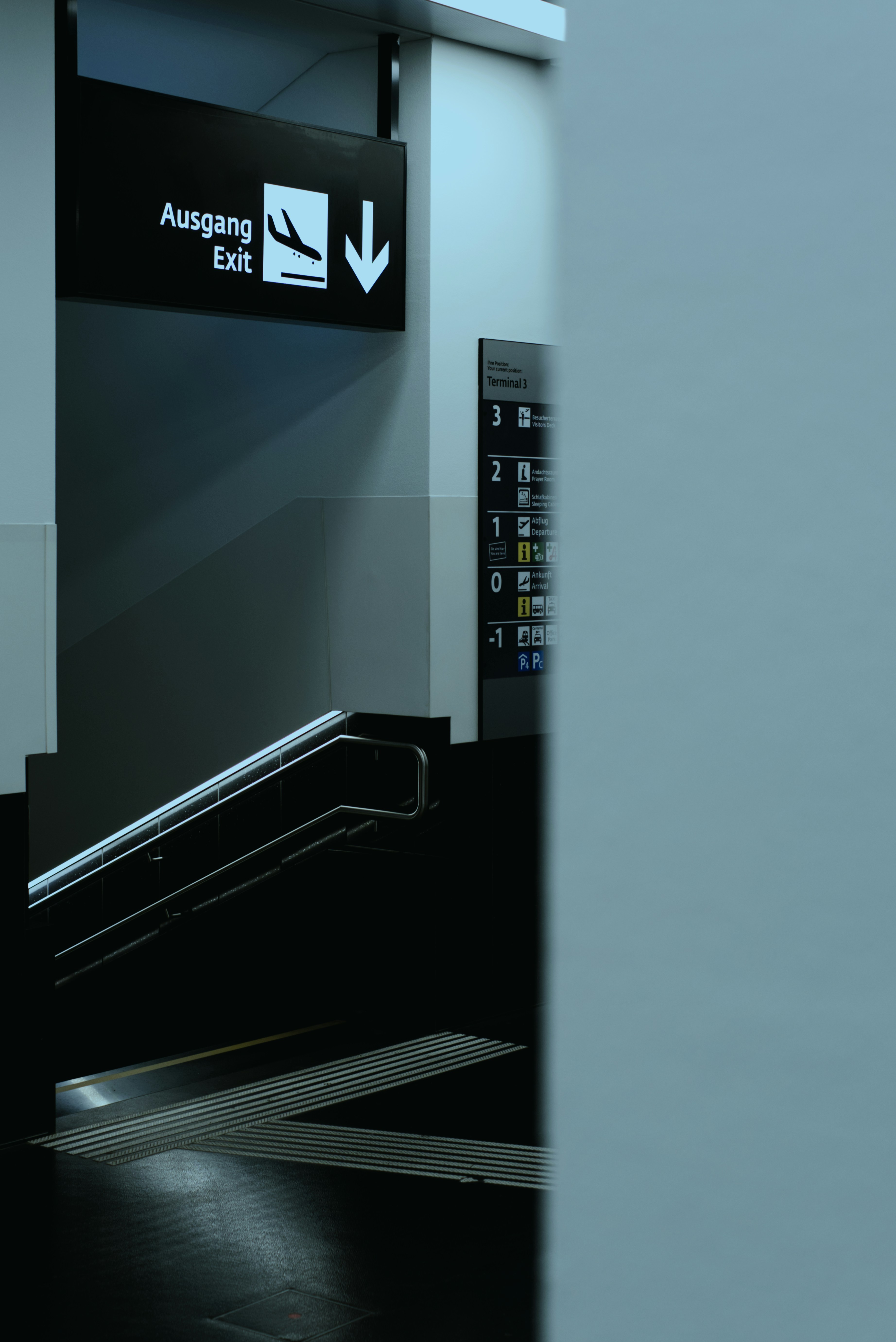 A black and white photo of an airport exit sign photo – Free Vienna ...