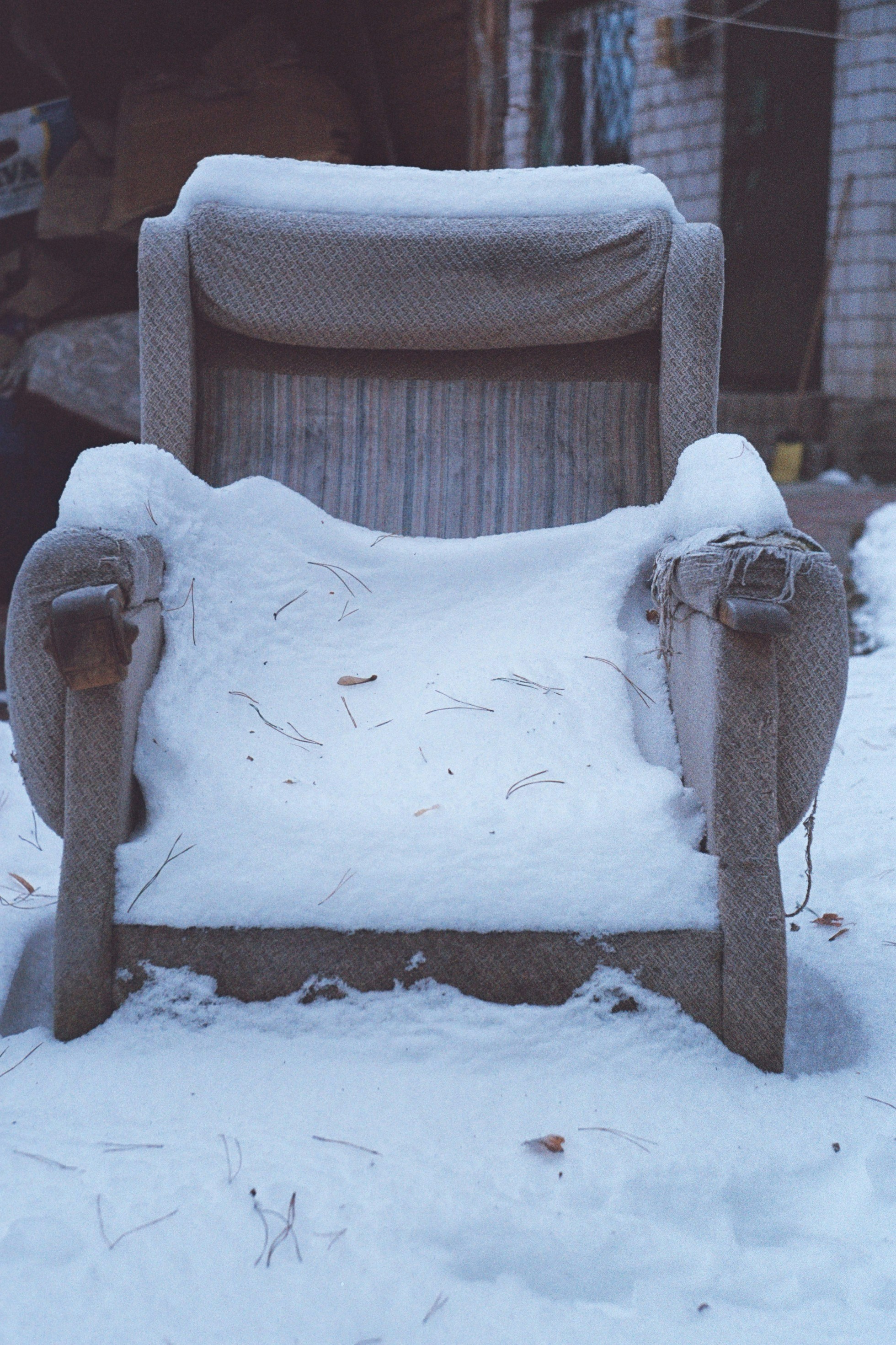 Snowbound Armchair in a Quiet Winter Yard