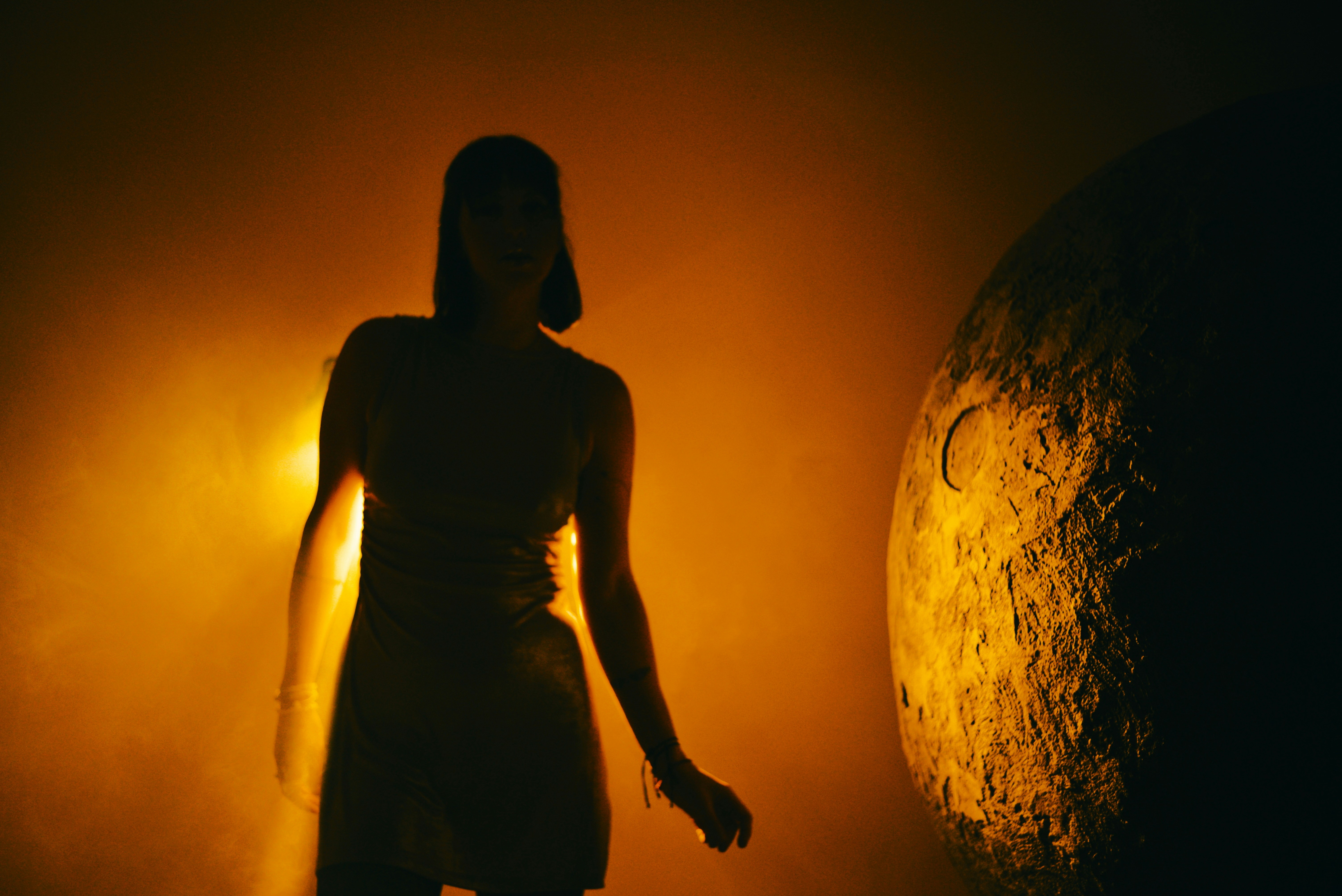 Shadowed Figure at the Edge of a Lunar Glow