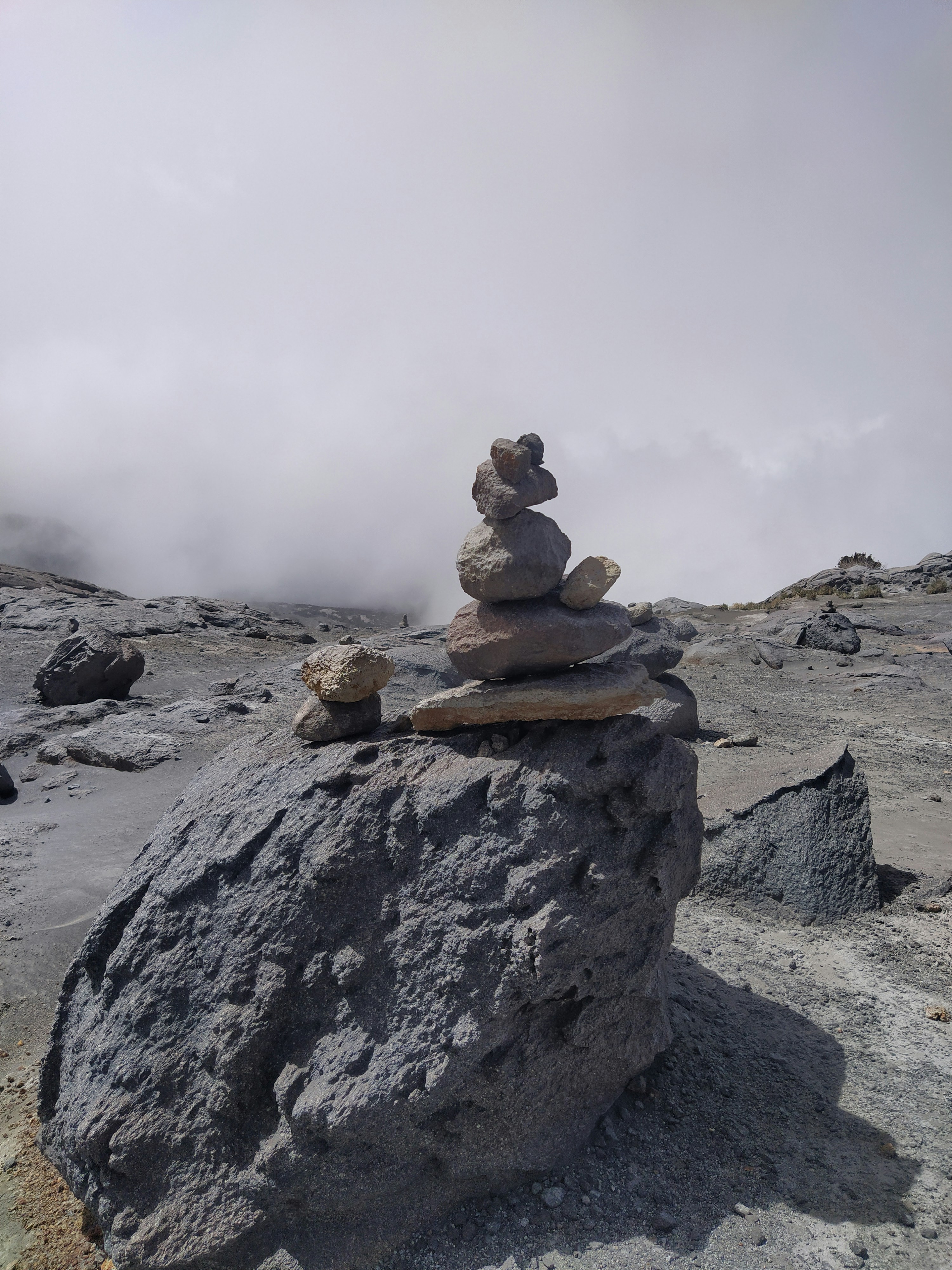 Cairns on a Lunar Lava Field Under a Cloudy Sky