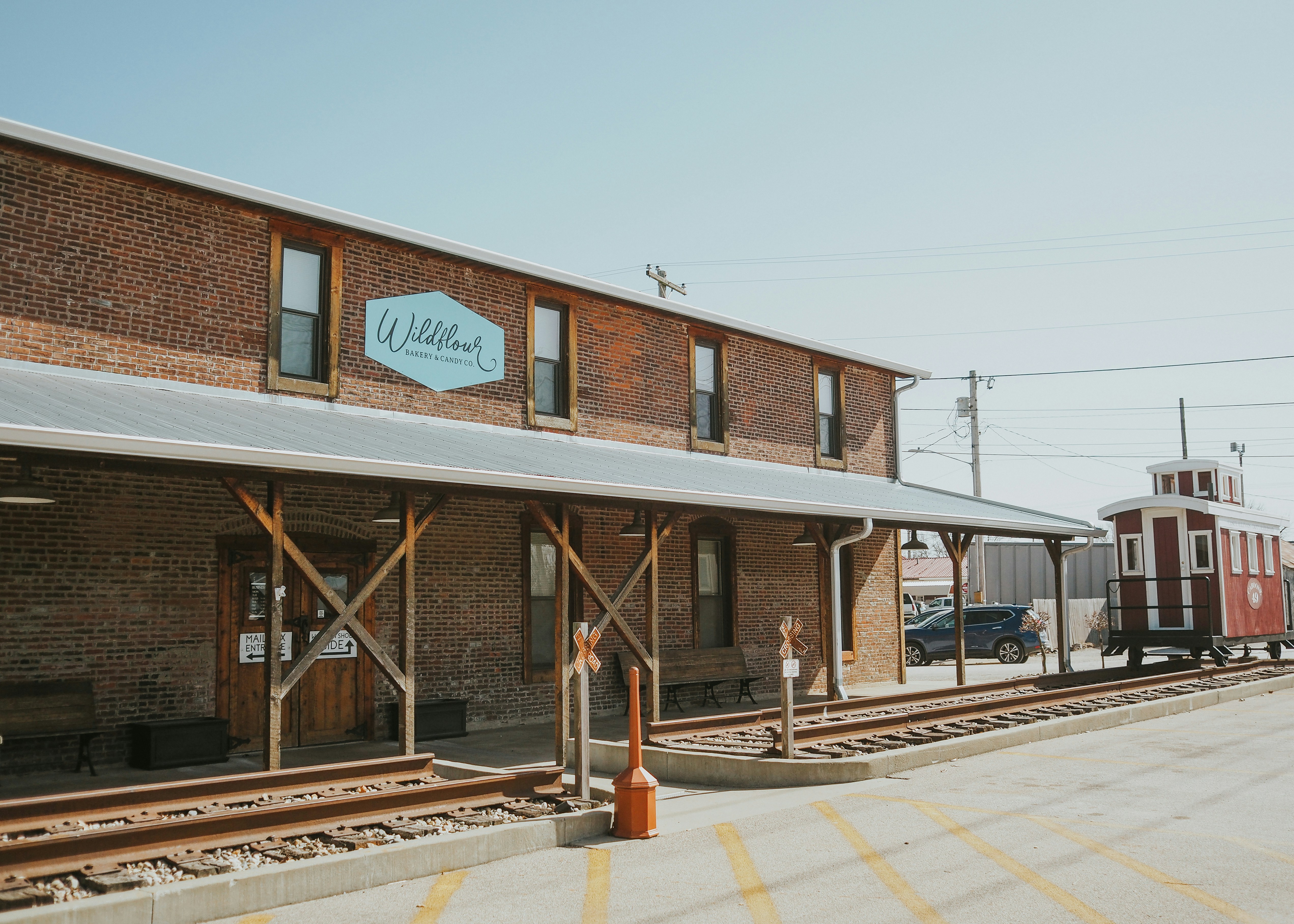 Sunlit Brick Depot: Veranda Beams and Rails