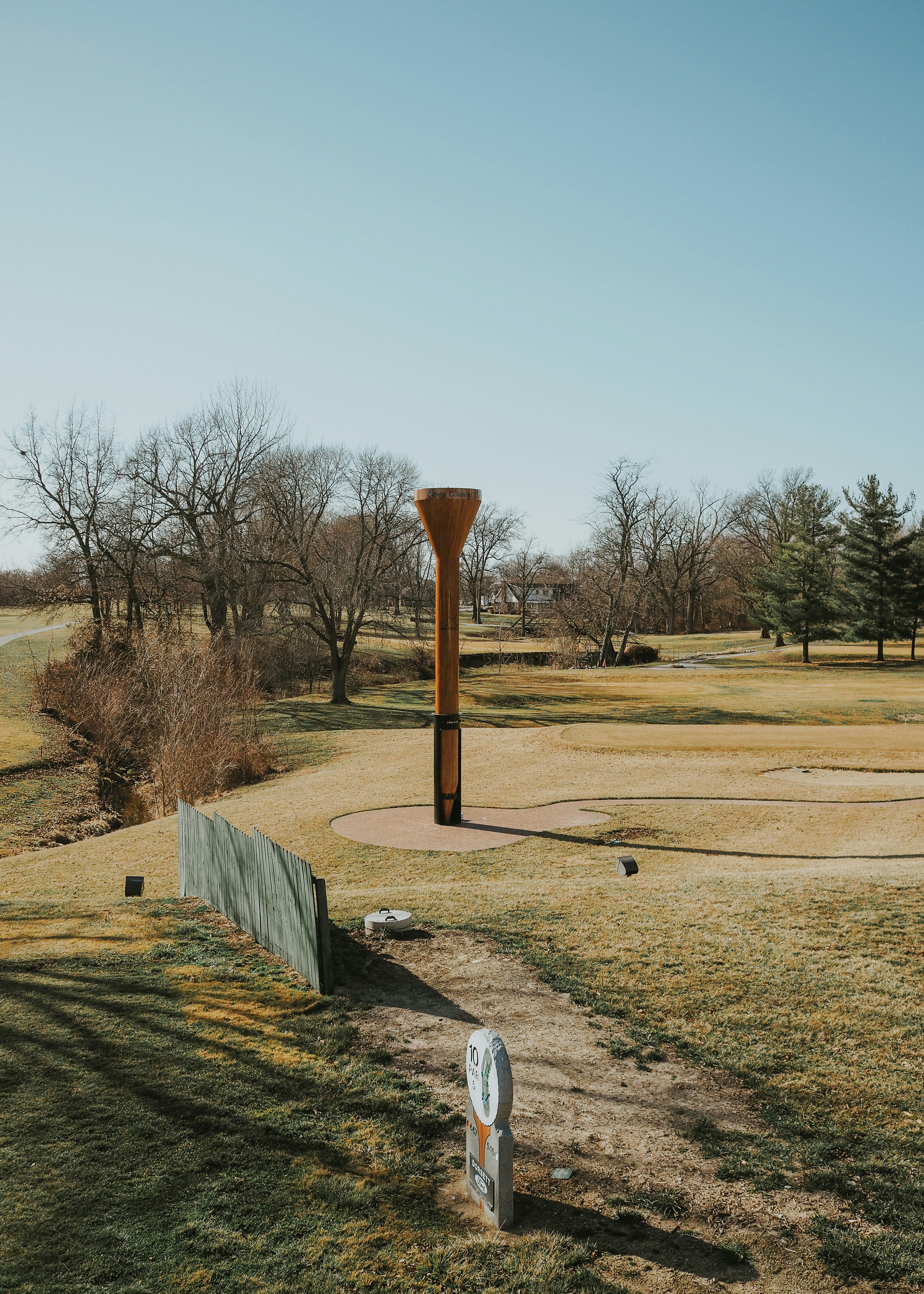 Copper Obelisk Above a Quiet Park Circle