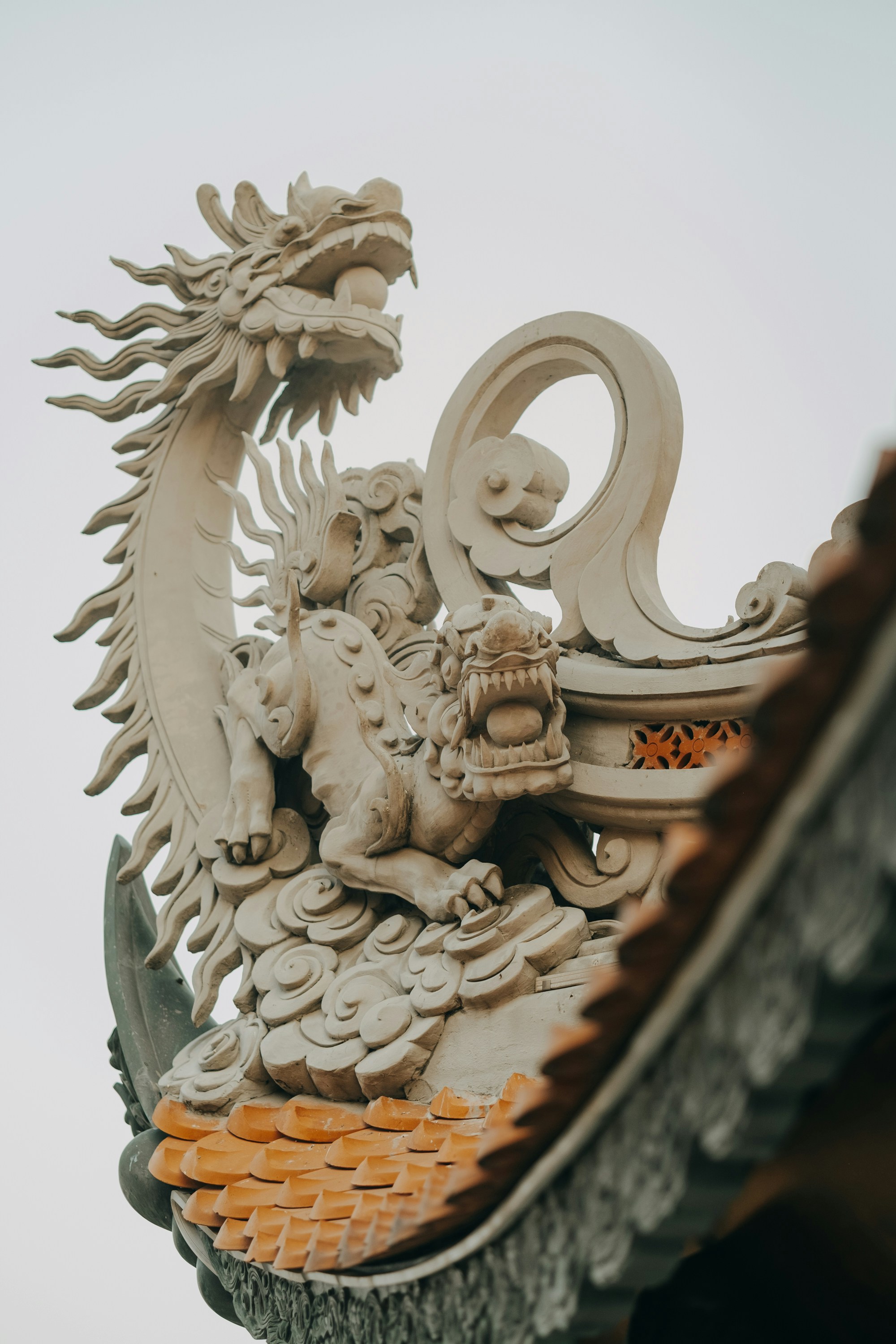 A statue of a dragon on top of a building photo – Free Image on Unsplash