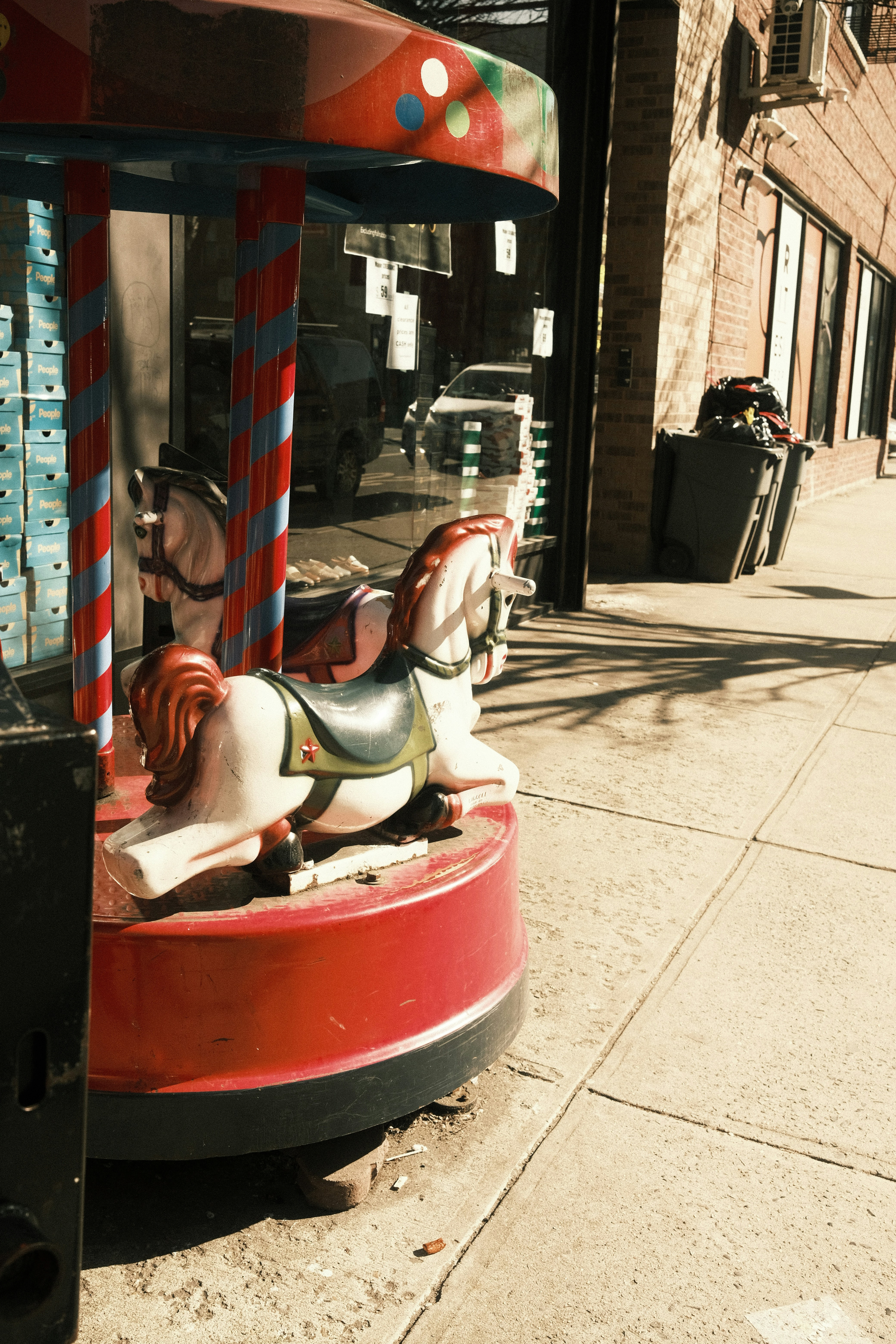 Sunlit Carousel Horse on a Quiet City Sidewalk
