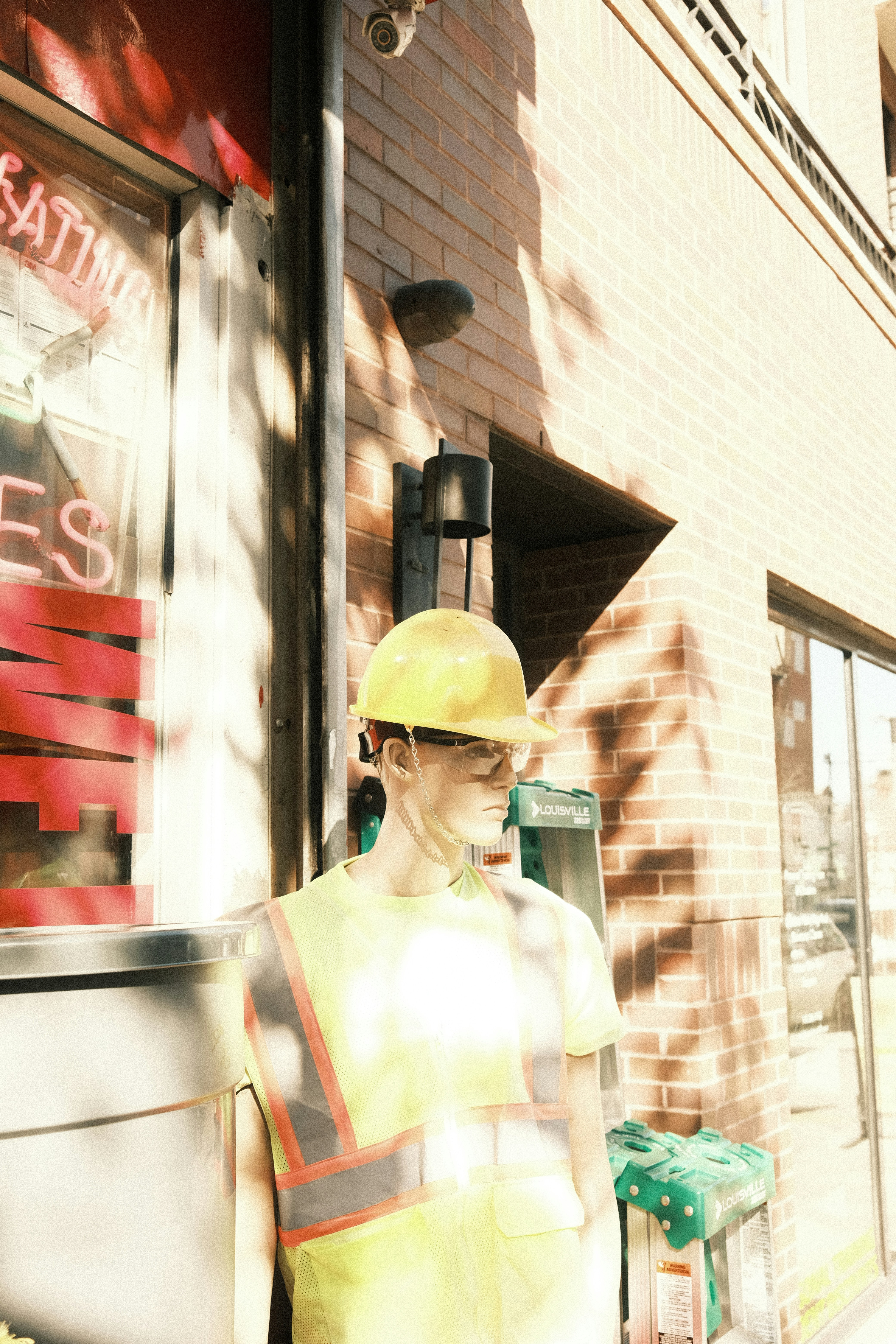 Yellow Helmet, Neon Vest, Brick Facade: A Street-Side Moment