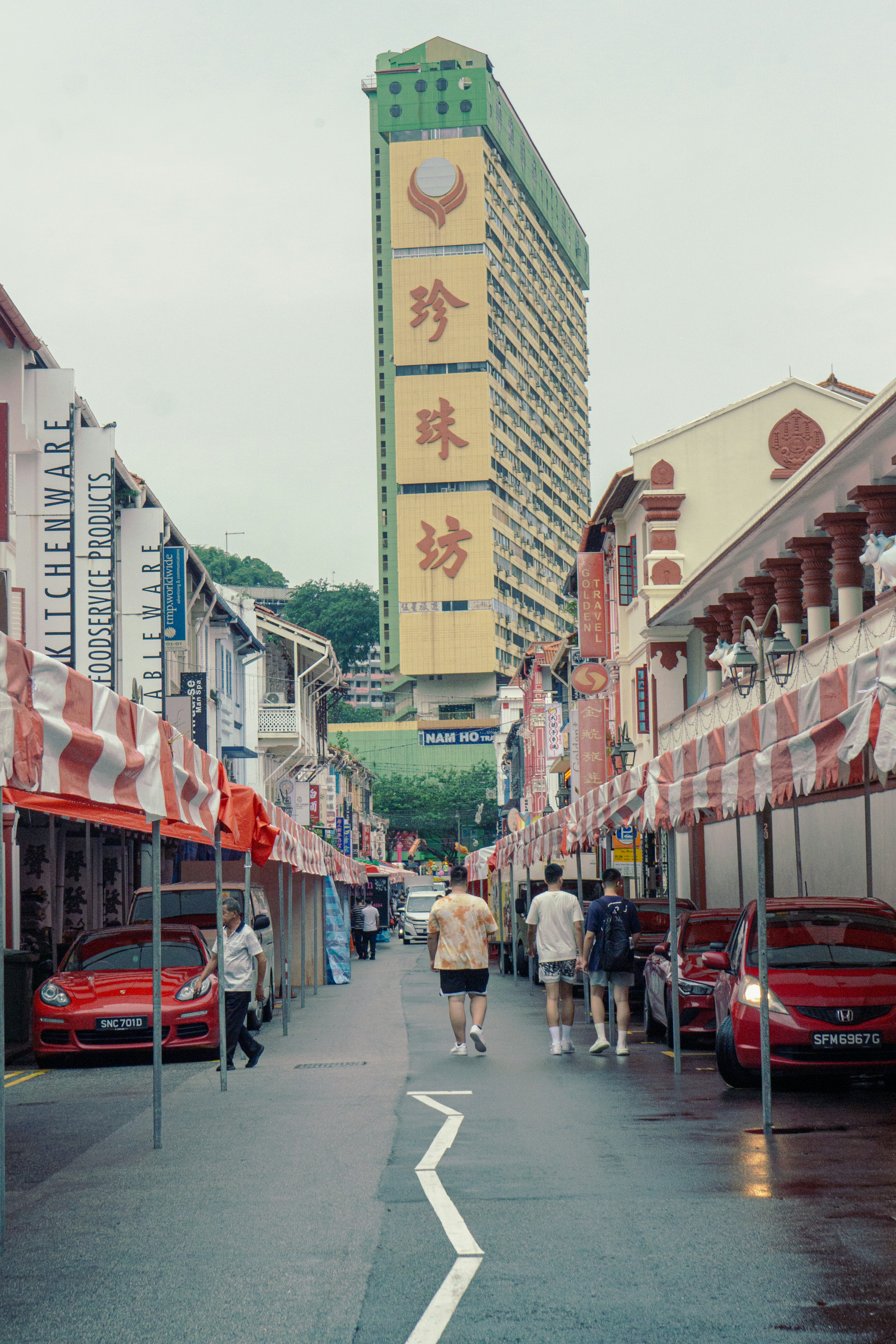 Streets of Lantern Tower: Market Row Beneath a Tall Sign