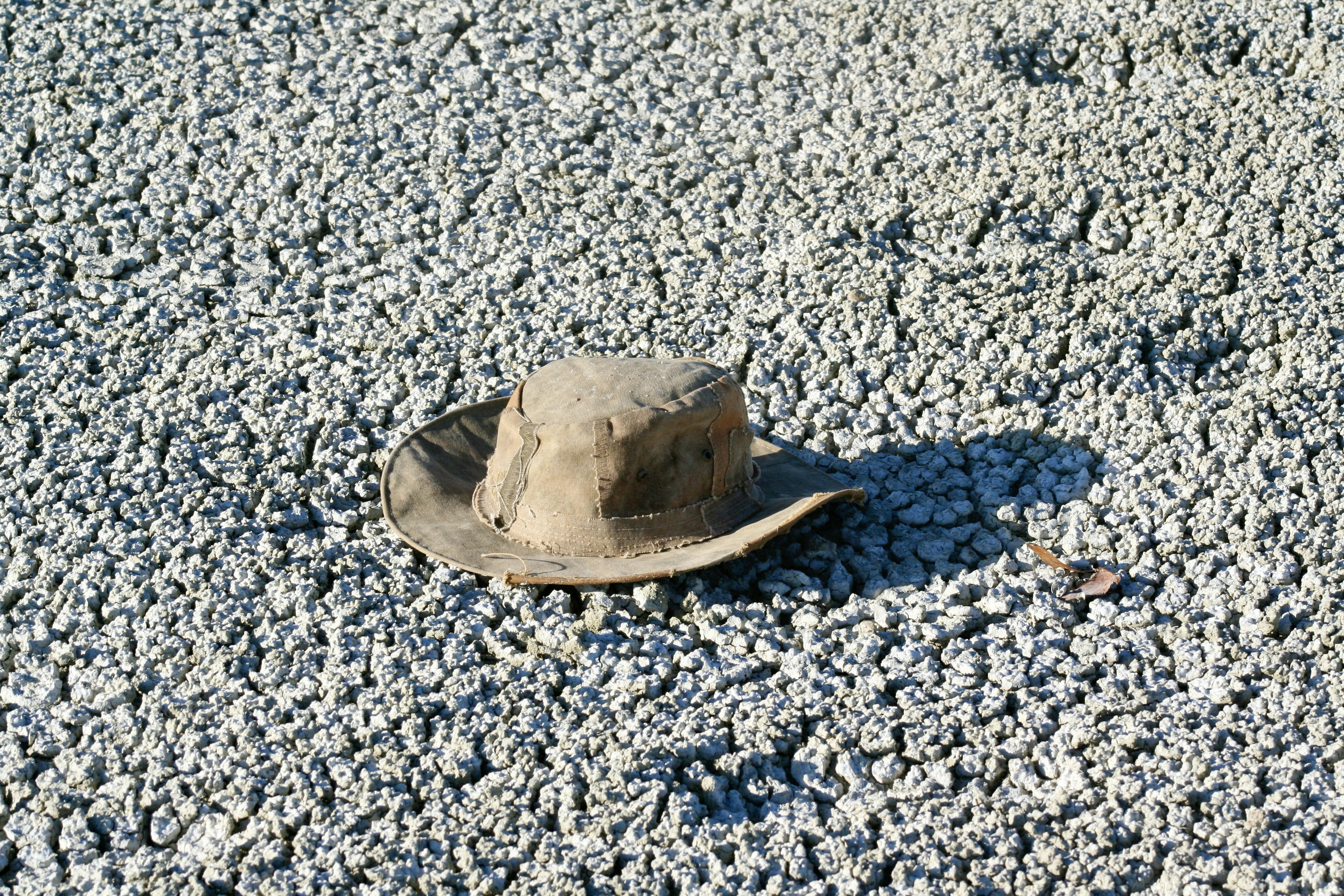Weathered Hat on a Sea of Moon-gray Pebbles