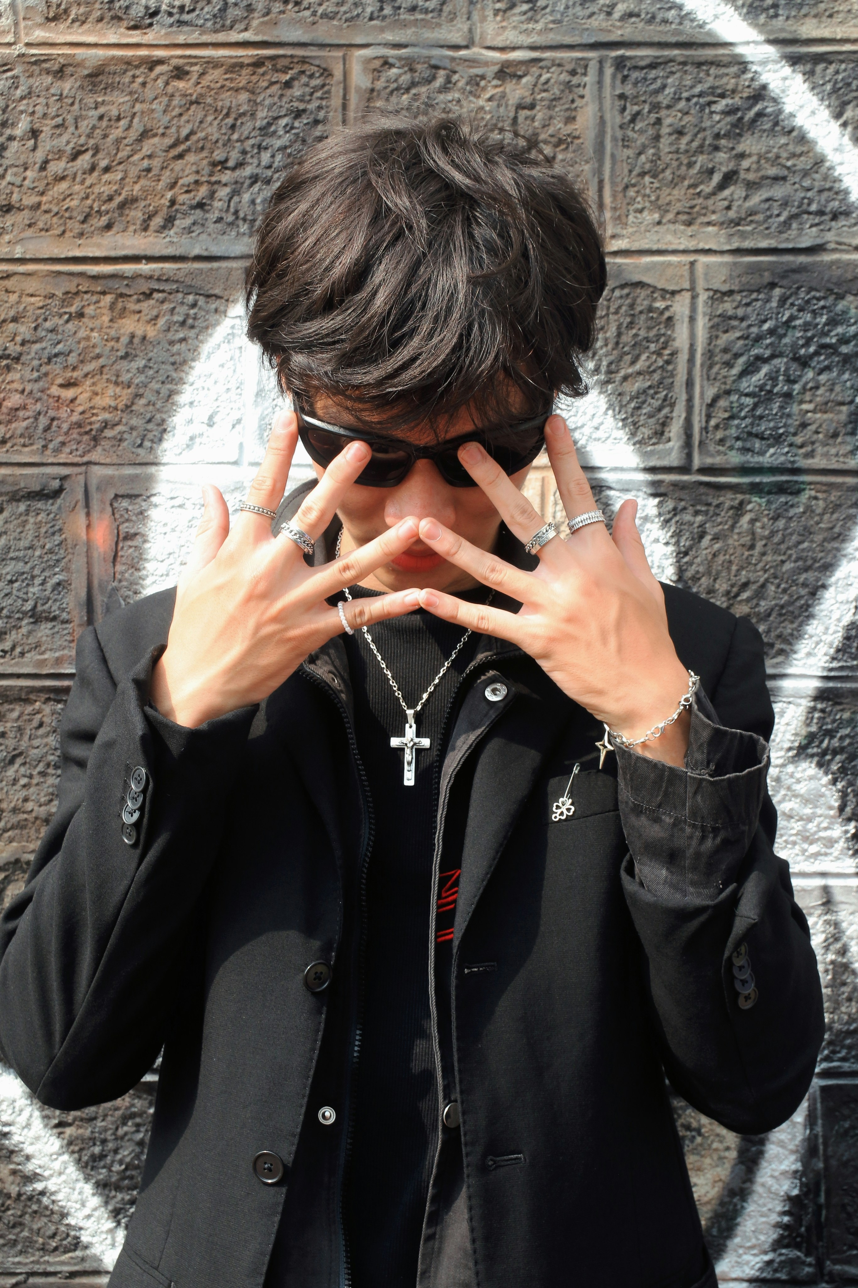 A man in a black jacket making a hand gesture photo – Free Portrait ...