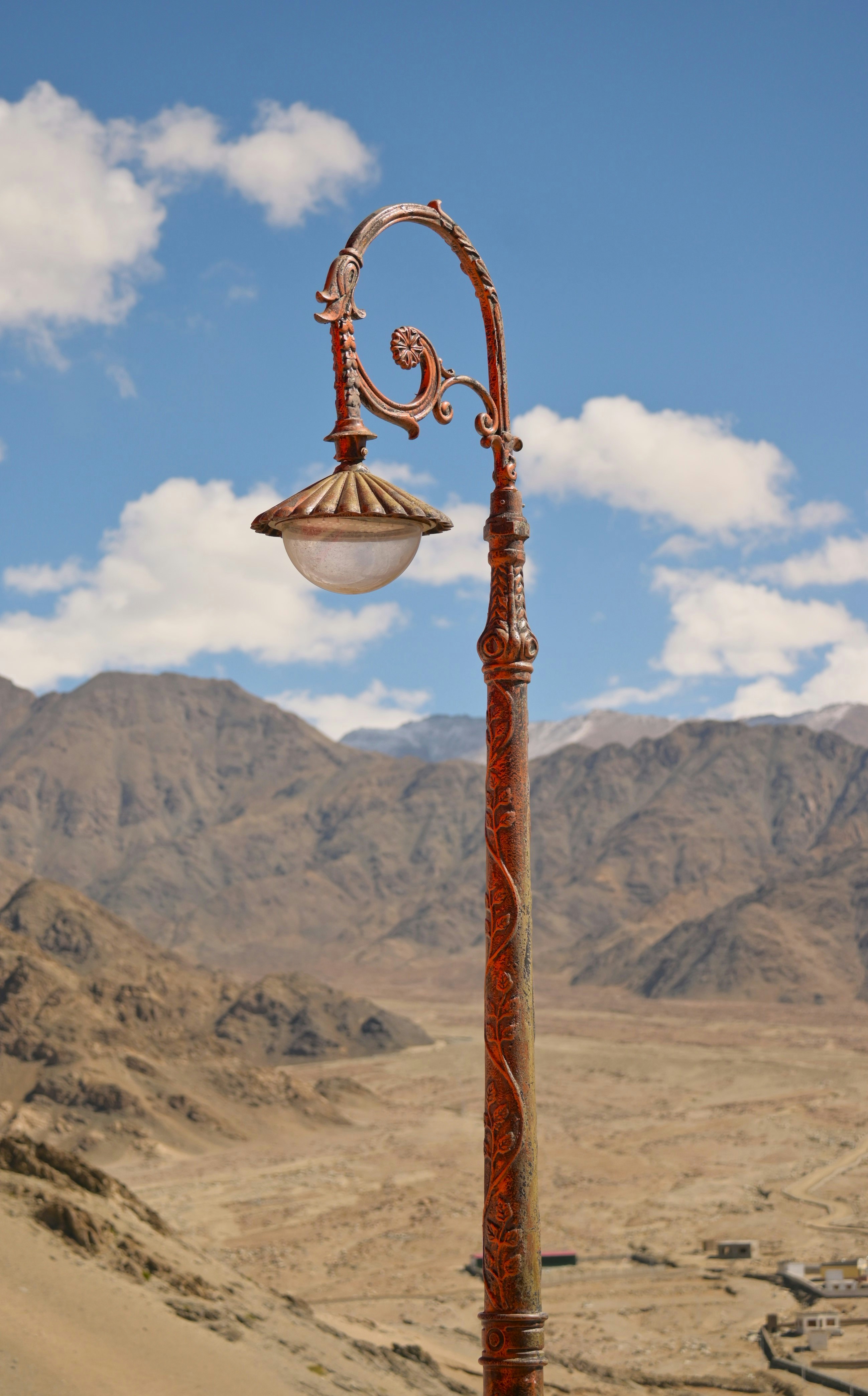 Rust-Red Ornate Lantern Standing Guard Over a Desert Valley