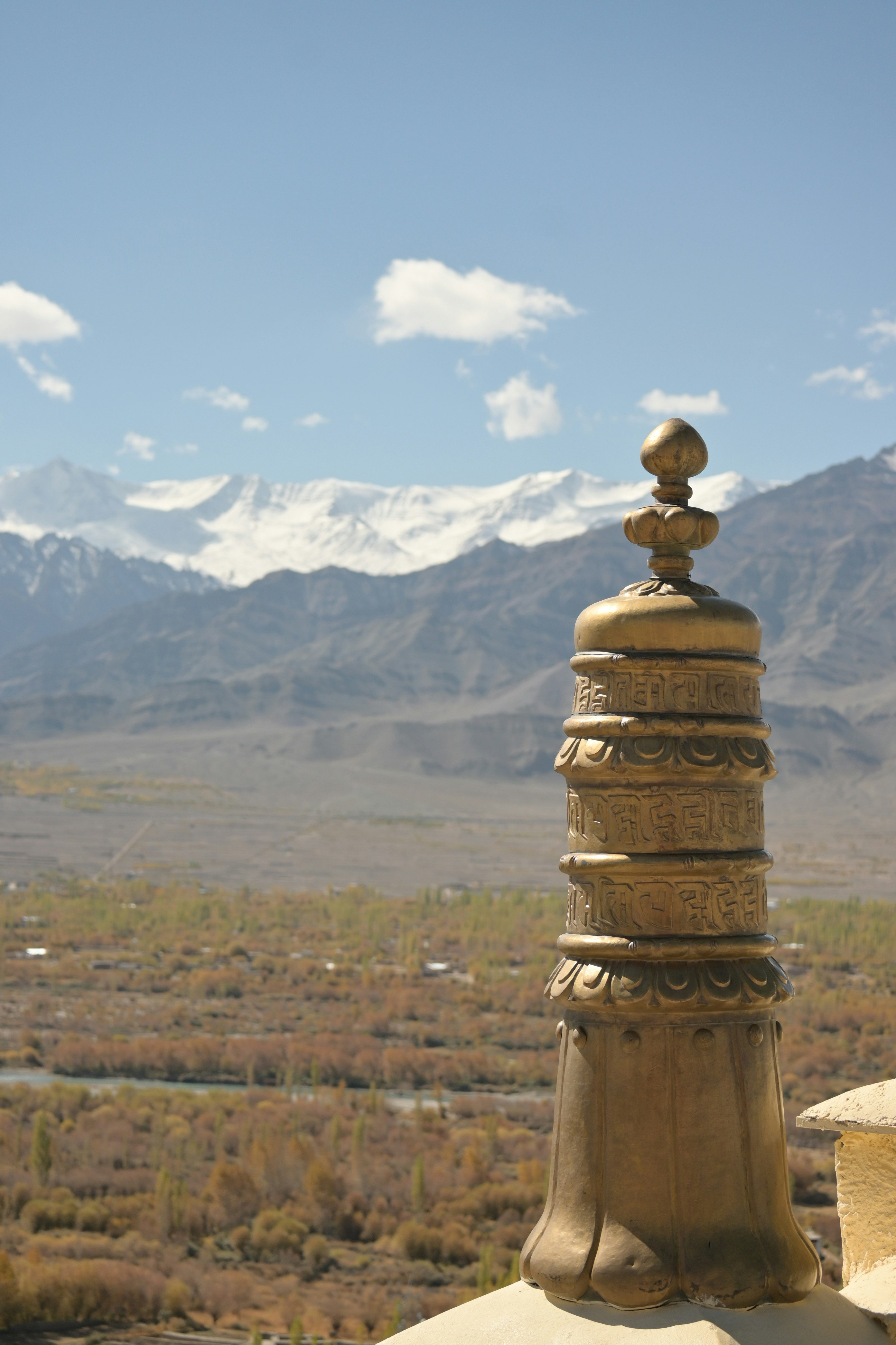 Golden Spire Amid Snow-Dusted Peaks