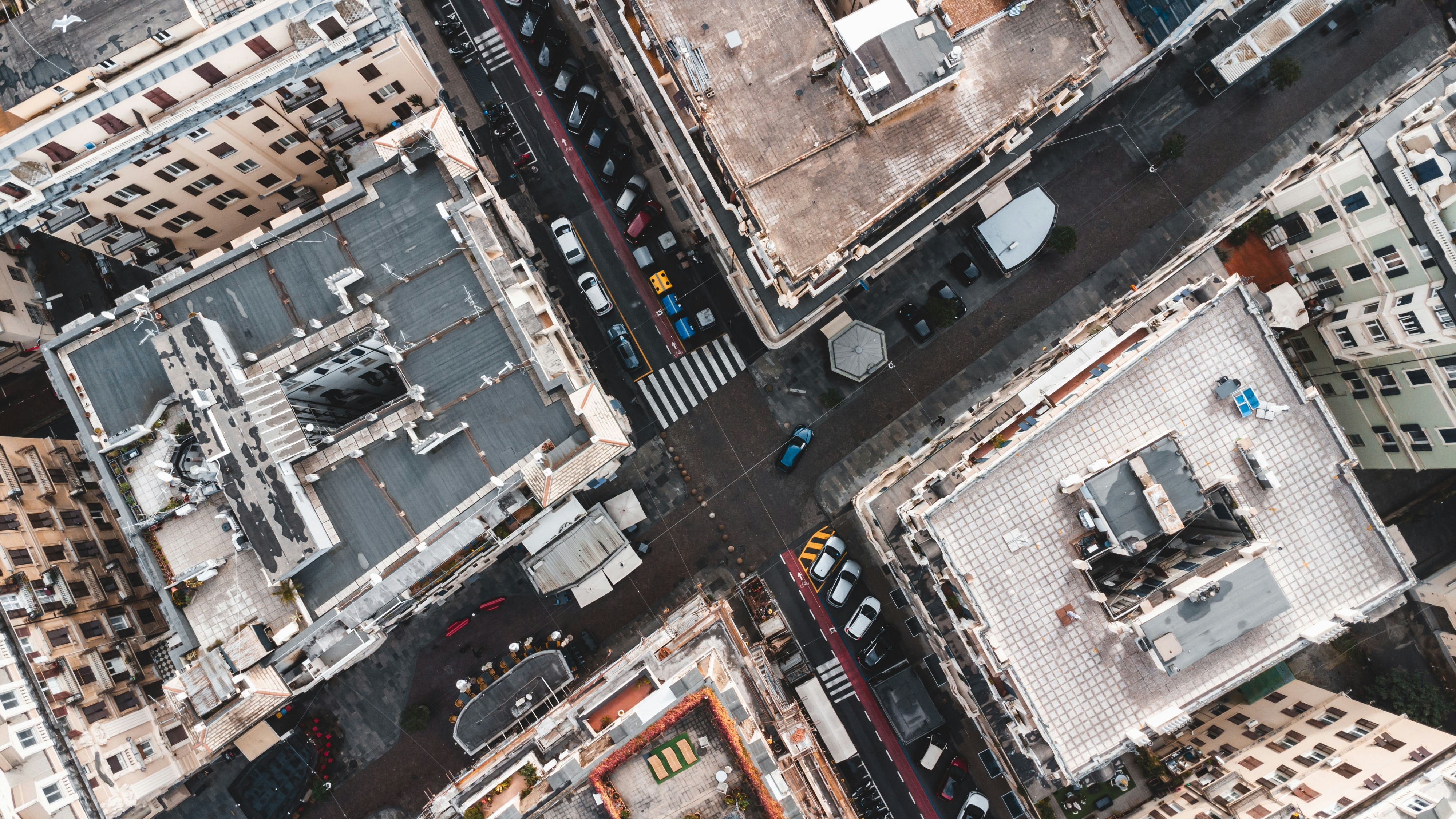 Aerial view of city streets intersecting among tall, detailed buildings.
