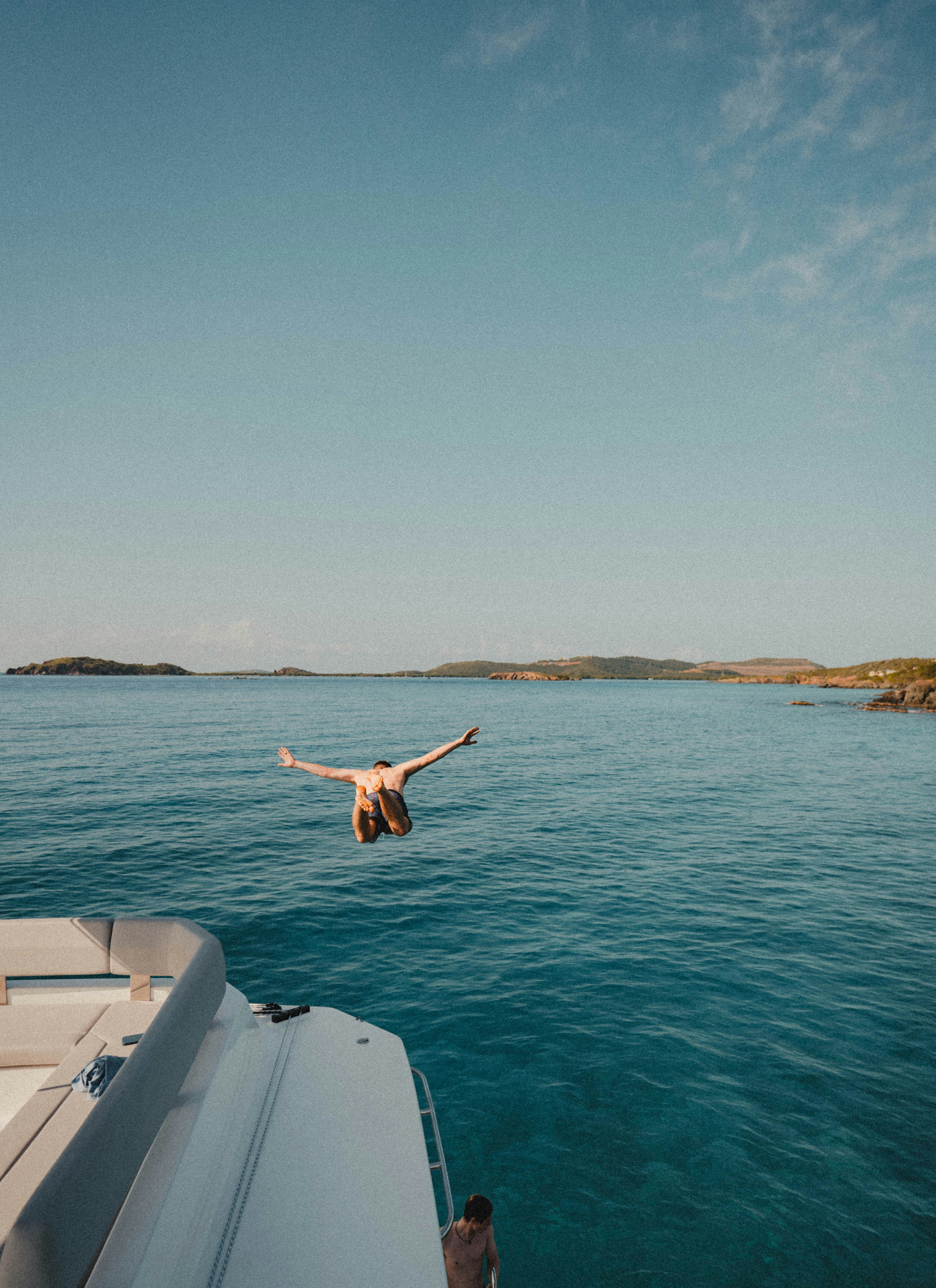 A person diving into the water from a boat photo – Free Grey Image on ...