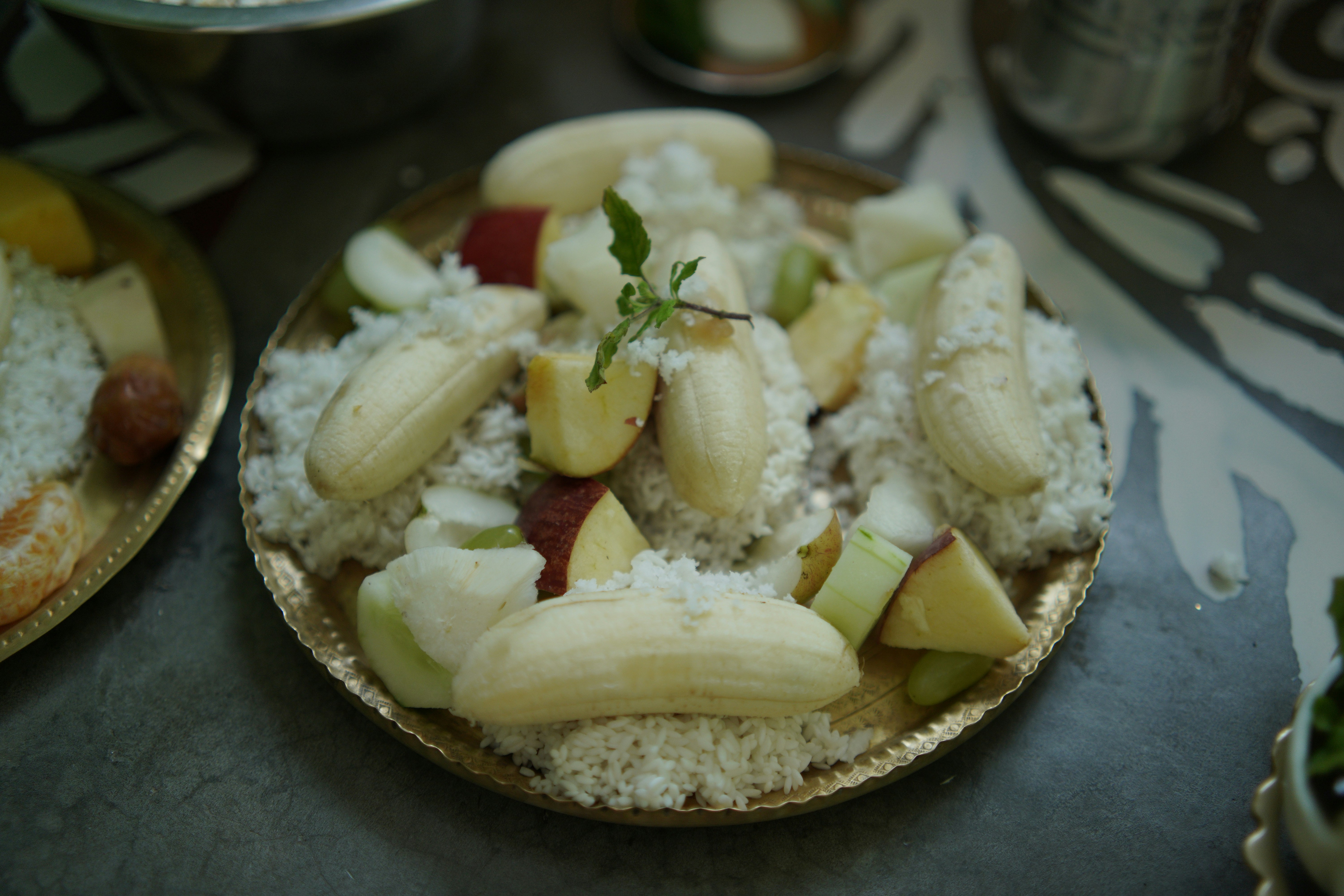 Banana Crown on Coconut Snow: A Tropical Treat on a Gold-Edged Plate