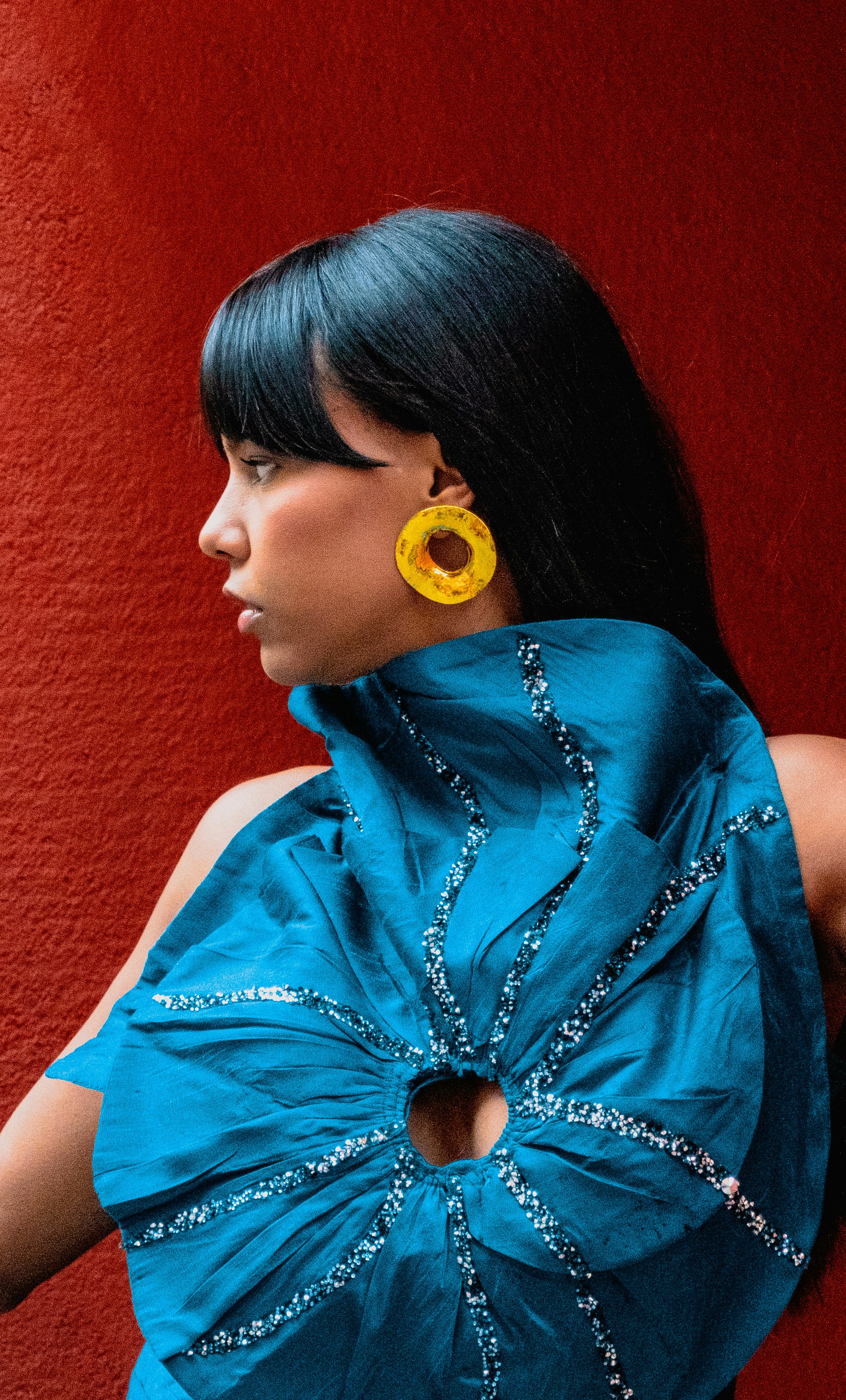 Azure Profile: The Yellow Hoop Portrait Against a Crimson Wall