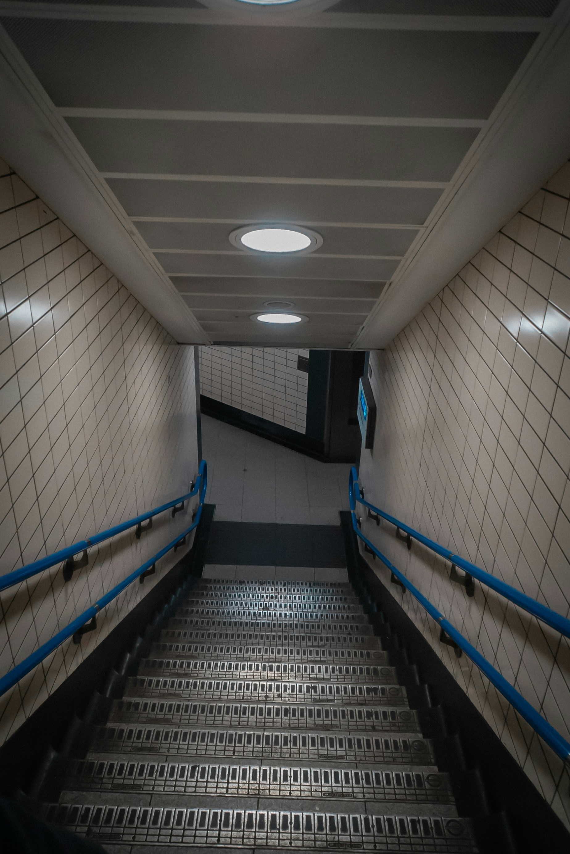 Underground Ascent: Neon Light and Metal Steps