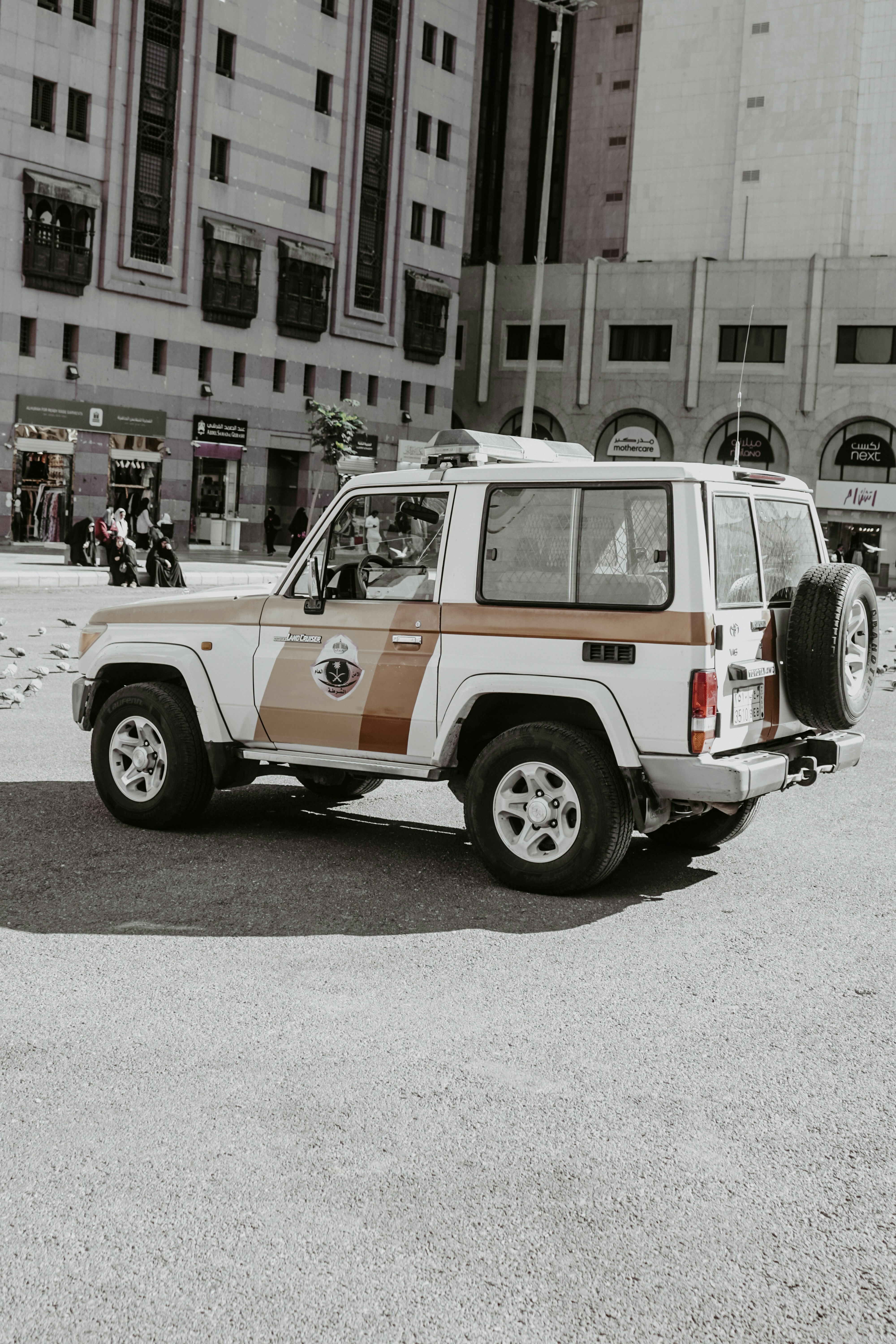 Urban Safari: The Classic SUV Stands Guard in a City Mall Quarter