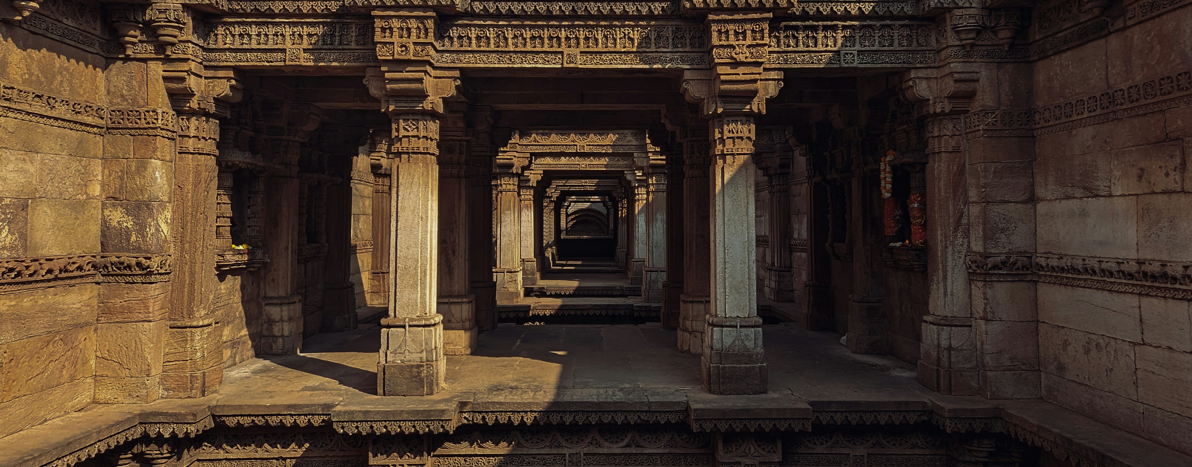 A stone building with pillars and pillars in it photo – Free Heritage ...