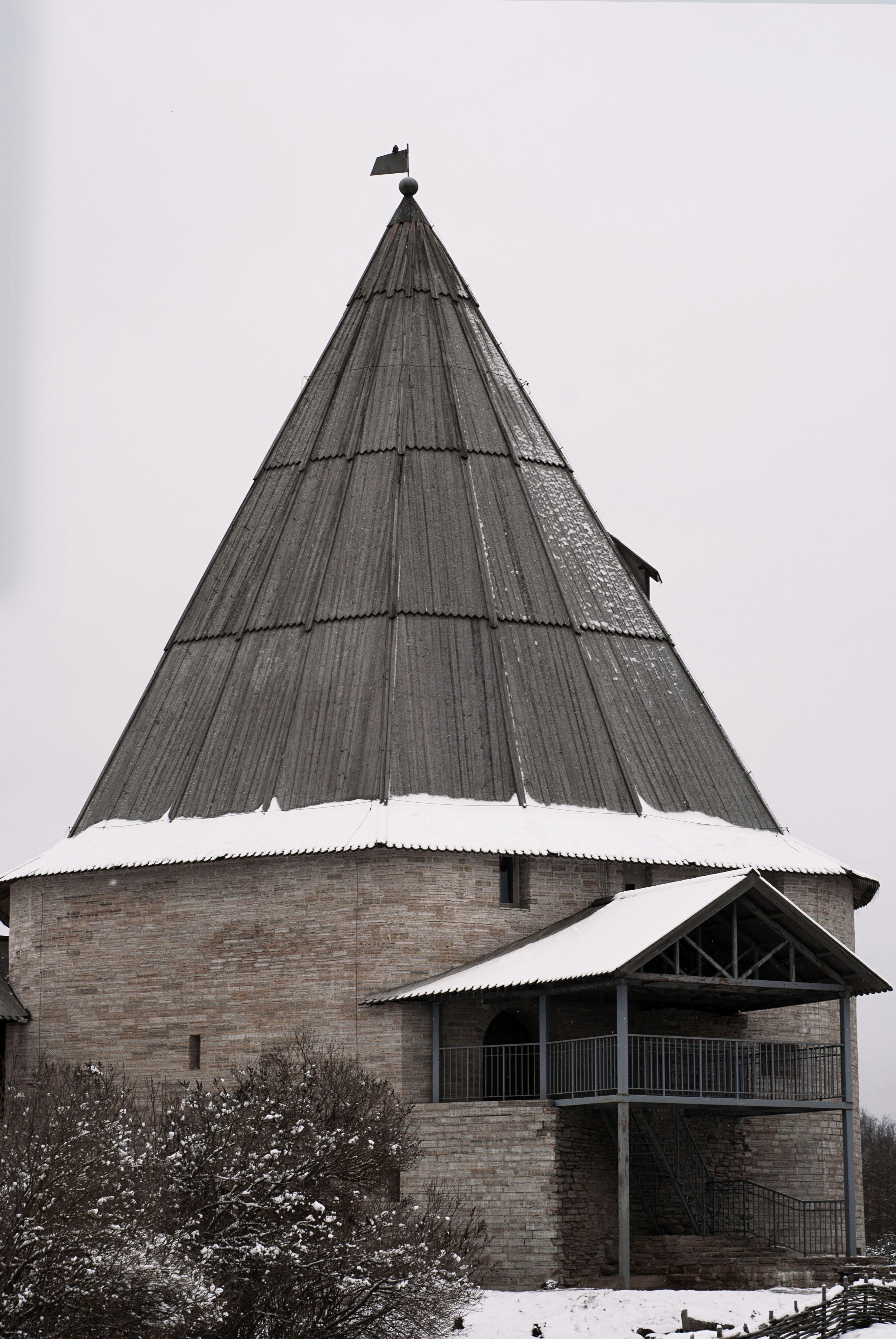 Snow-Capped Conical Turret: A Rustic Winter Watchtower