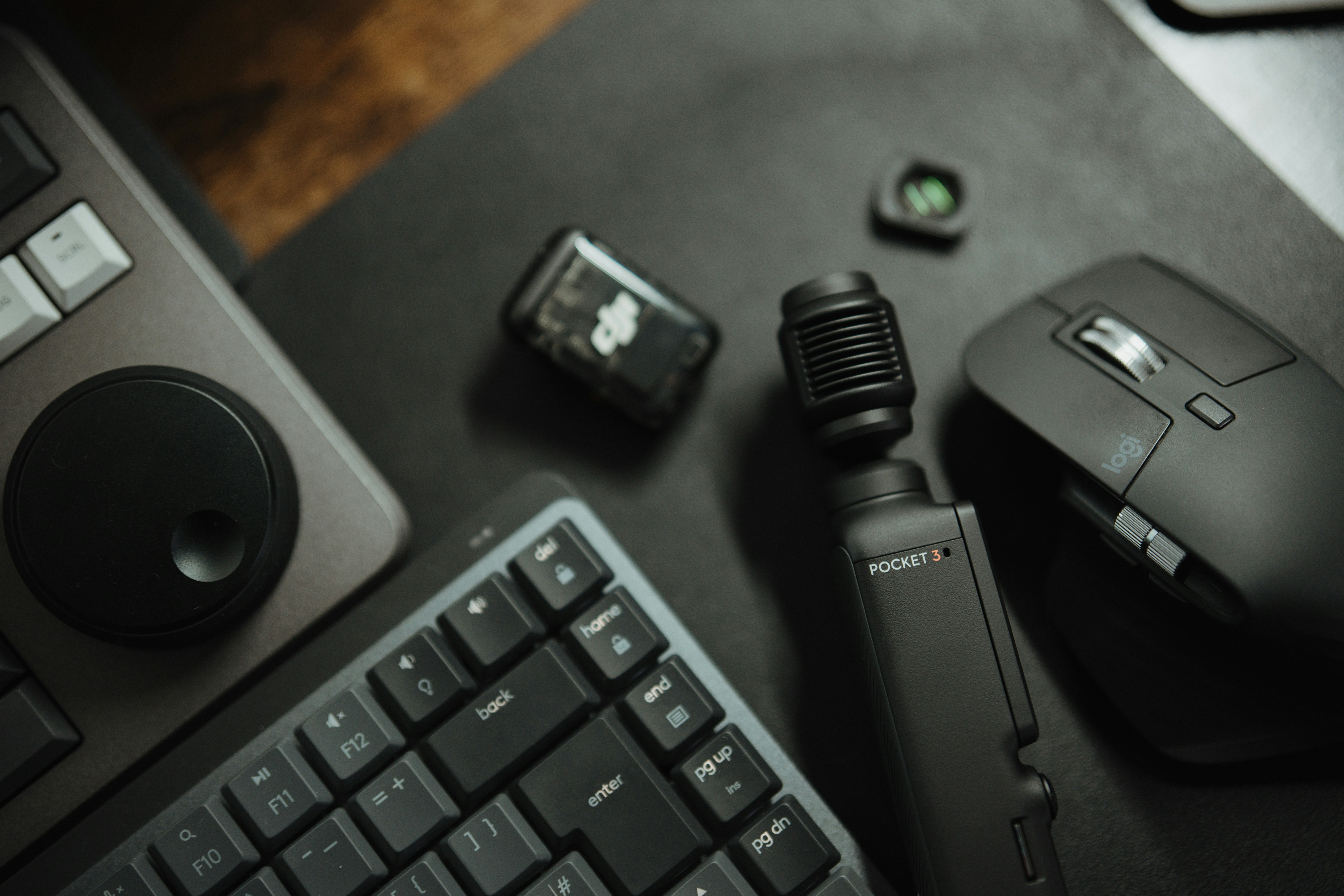 A computer keyboard, mouse, and other electronics on a desk photo ...