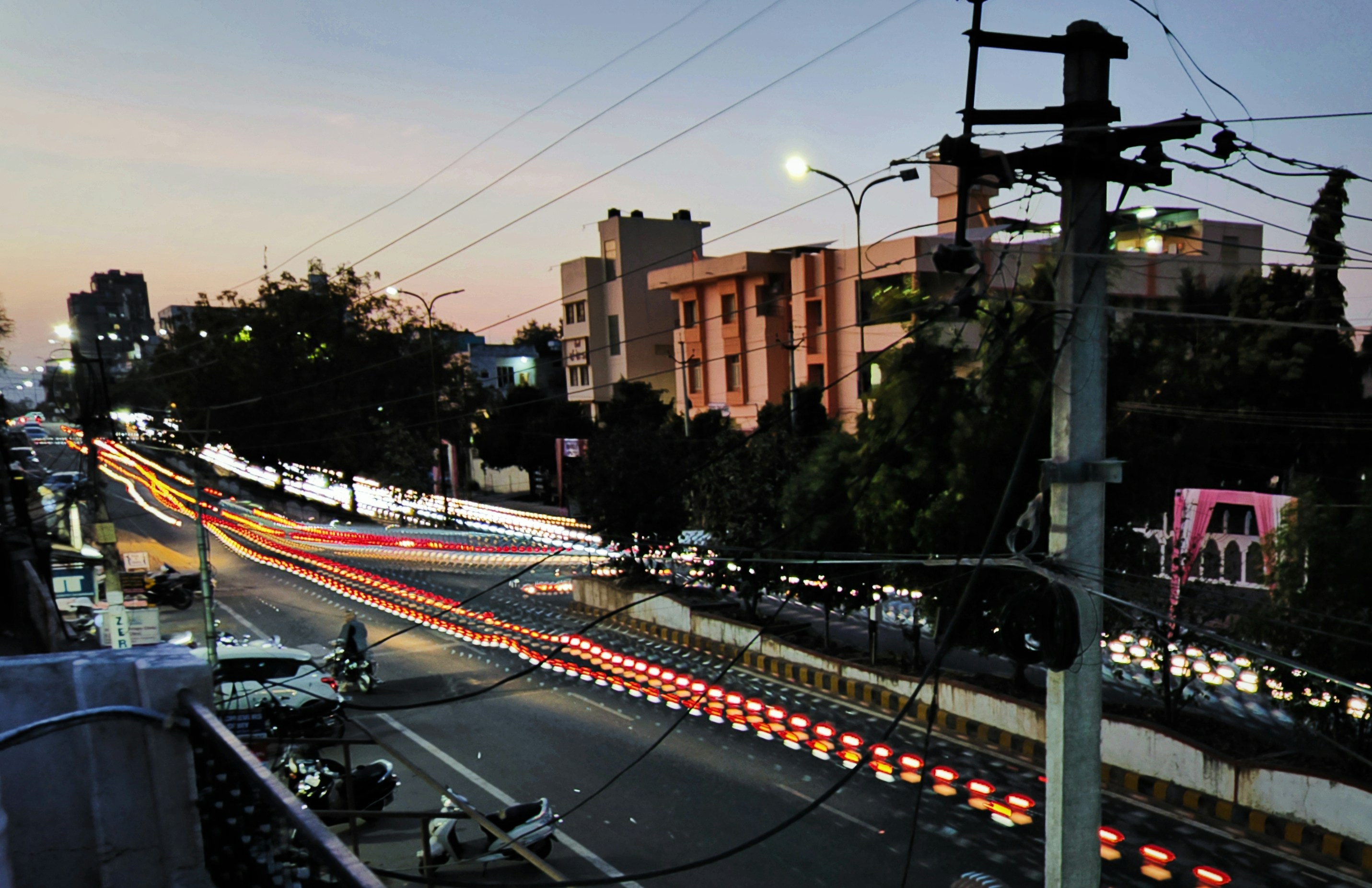 Vanishing Point Over a Rooftop Street: Night Light Trails