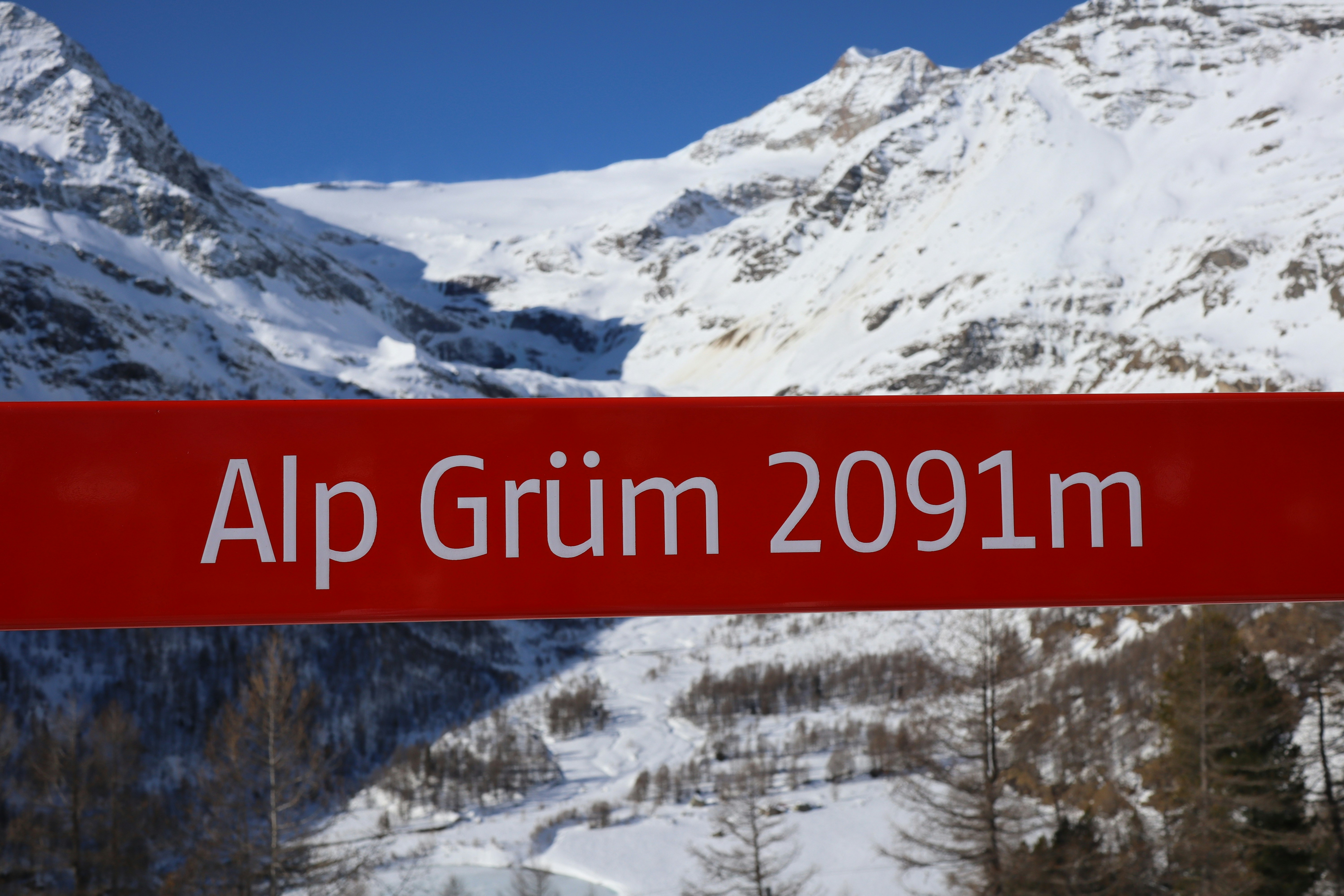 Crimson Alp Grüm Sign Over Snow-Capped Giants, 2091m