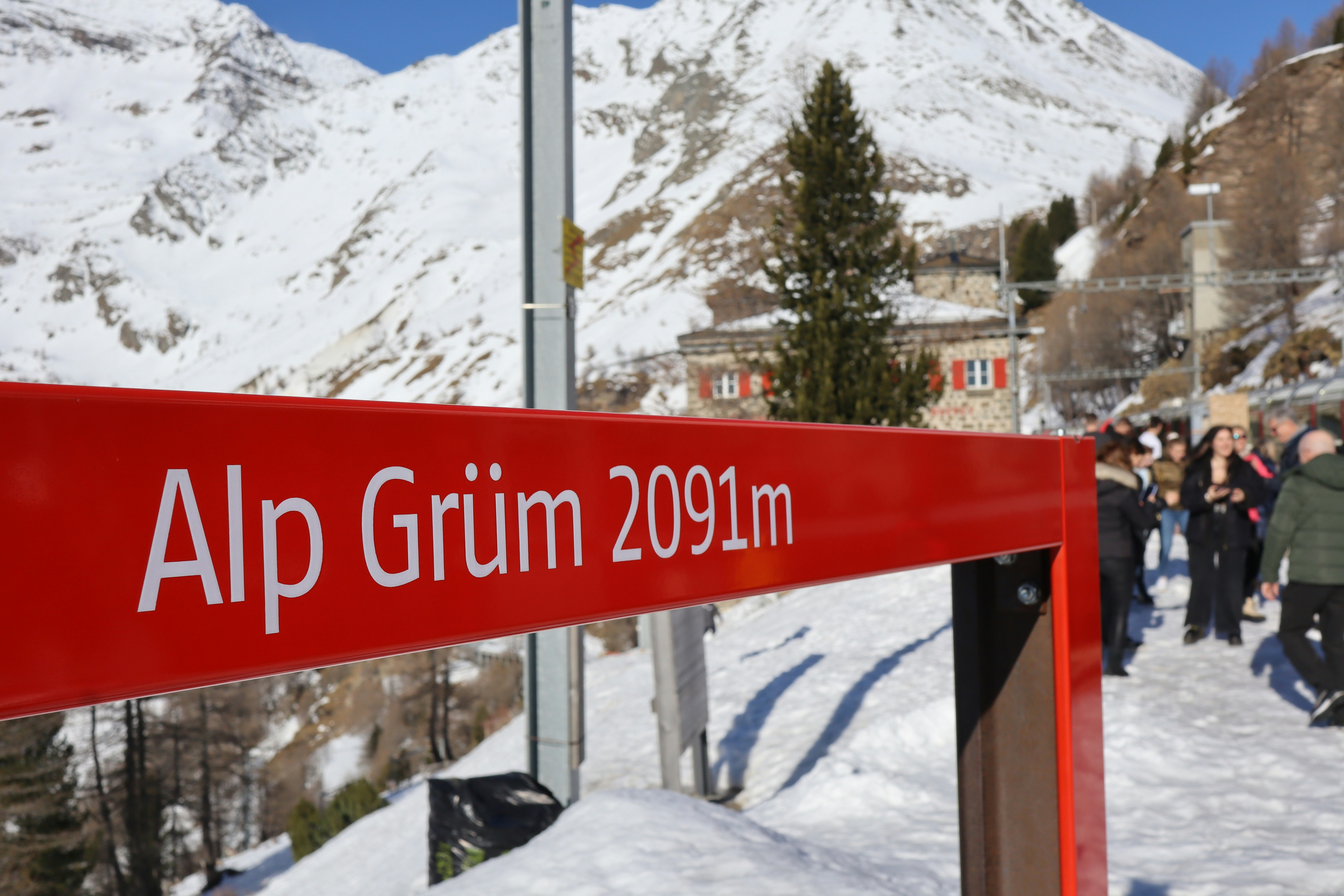 Summit Signage at Alp Grüm: A Gateway to the Alps