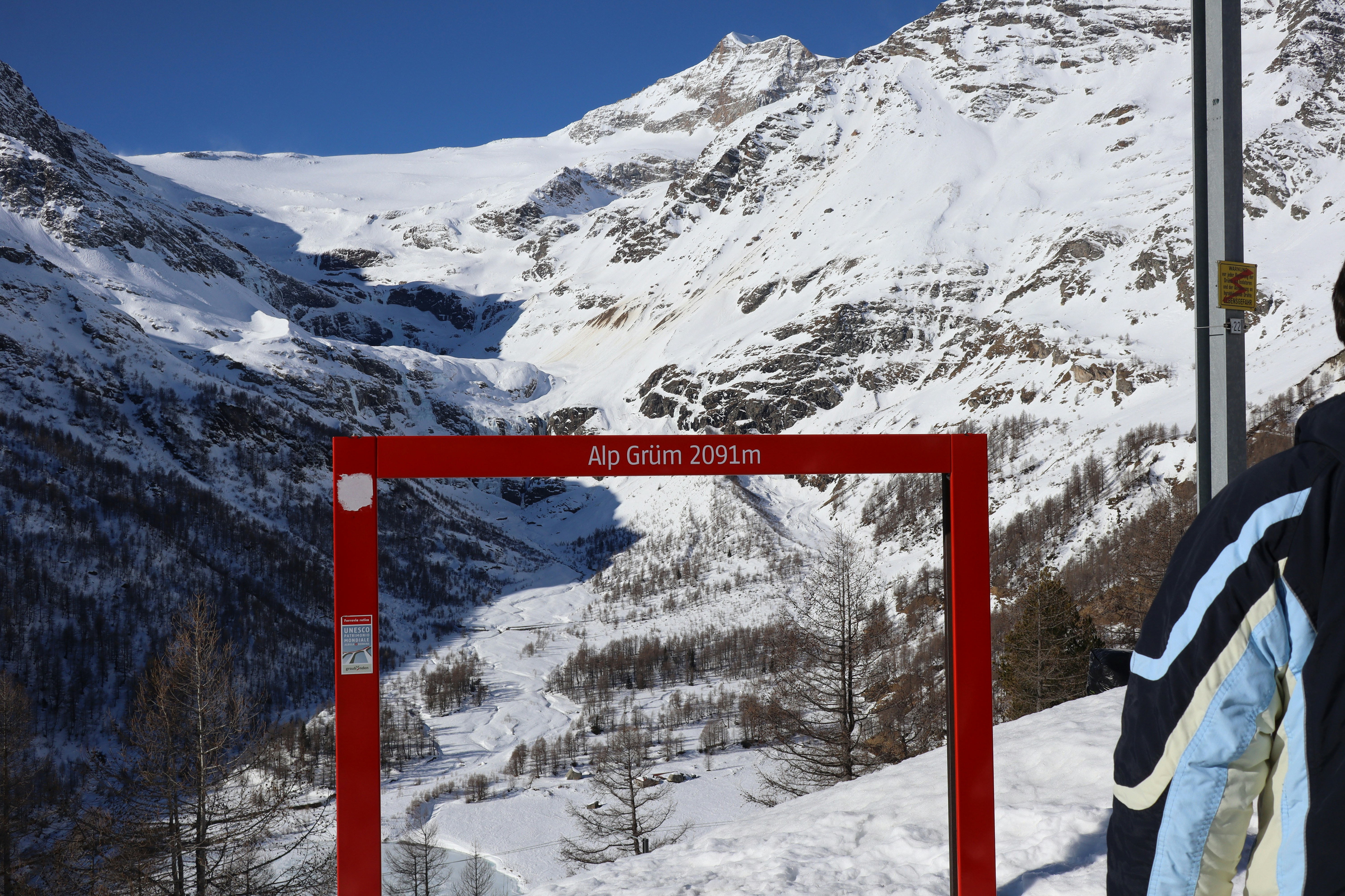 Red Frame Over Snowy Alps: Alp Grüm Gate Framing the Peak Line