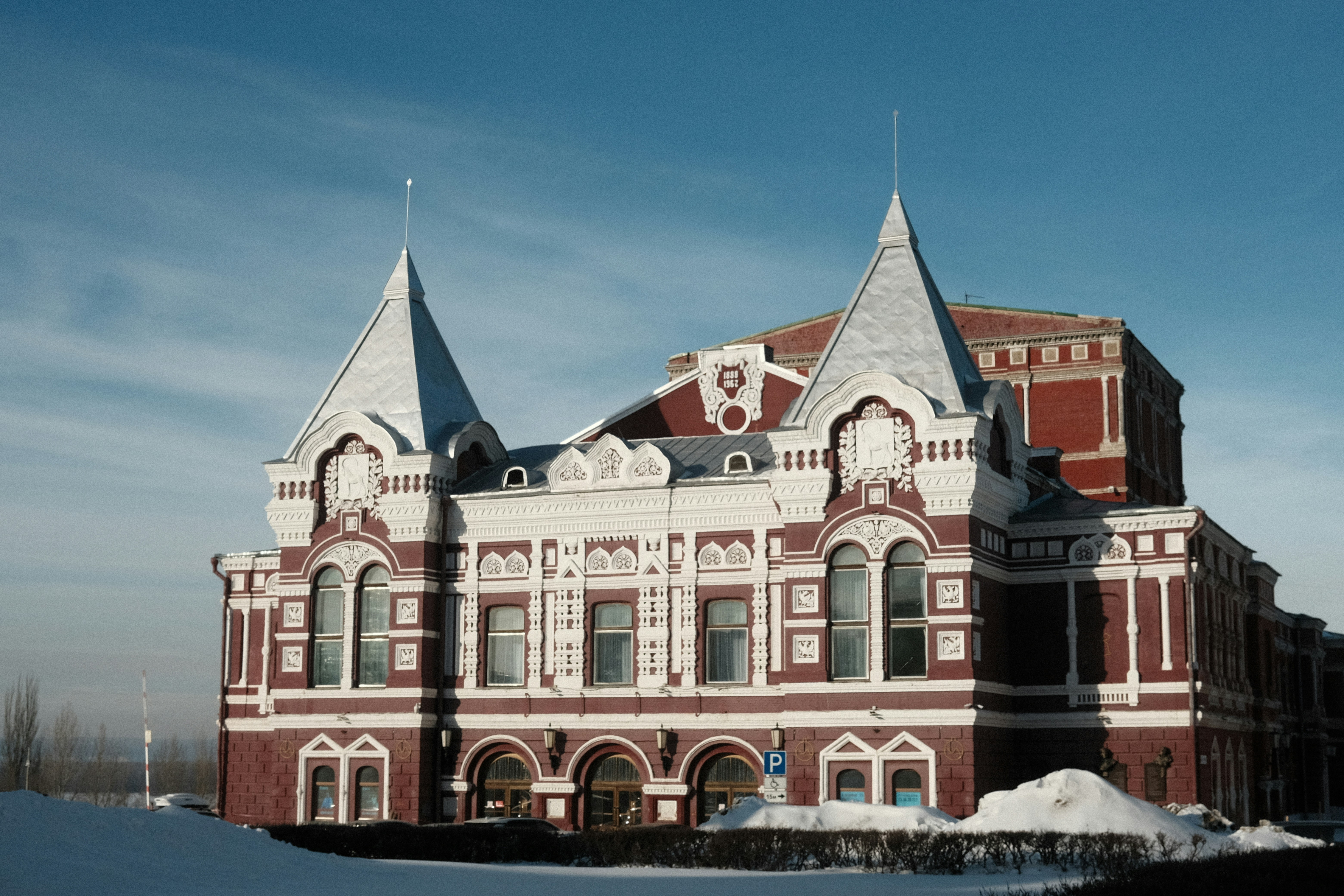 Red Brick Facade in Snowlight, Neo-Romanesque Revival Under a Clear Winter Sky