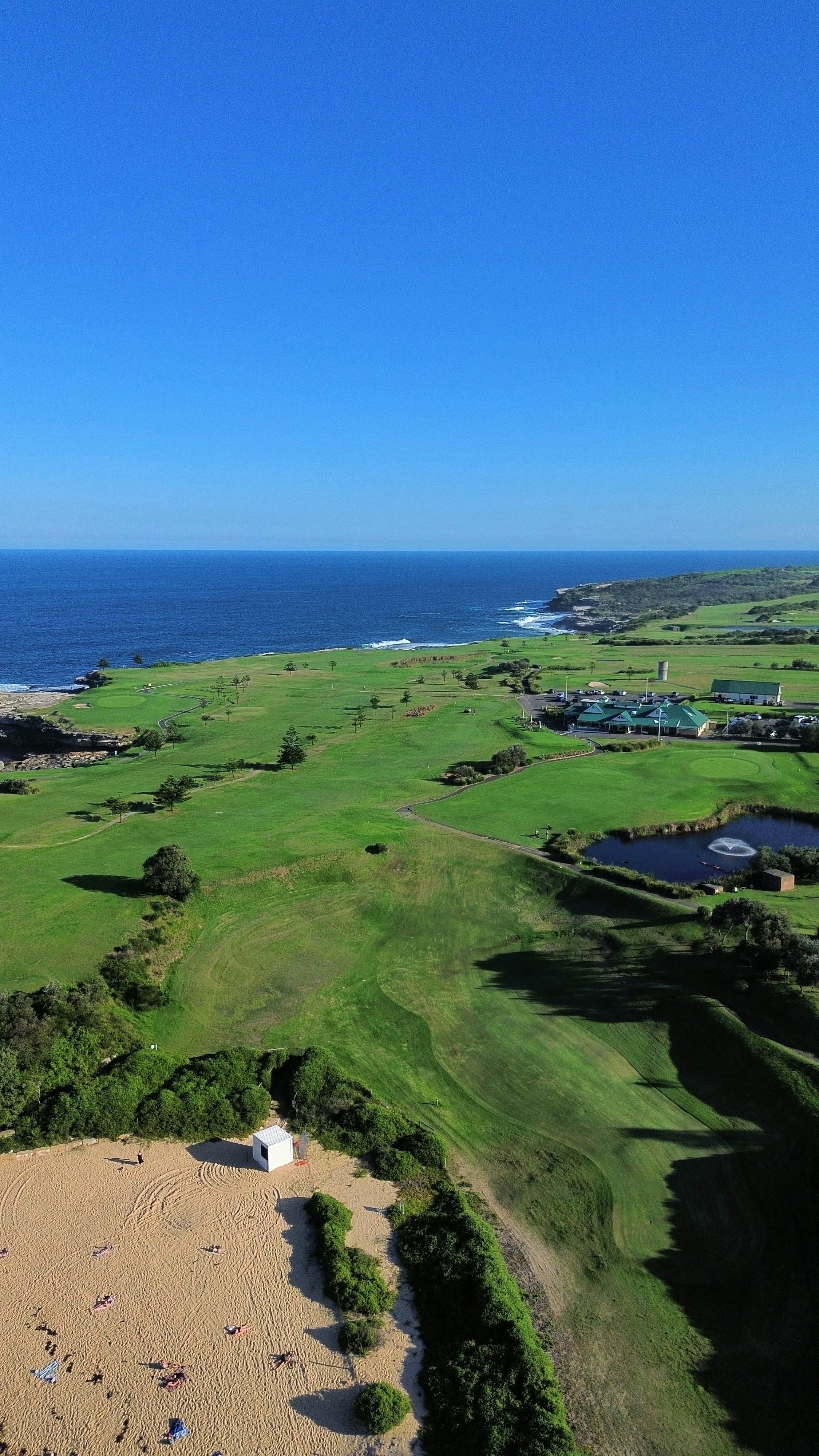 An aerial view of a golf course near the ocean photo – Free Little bay ...