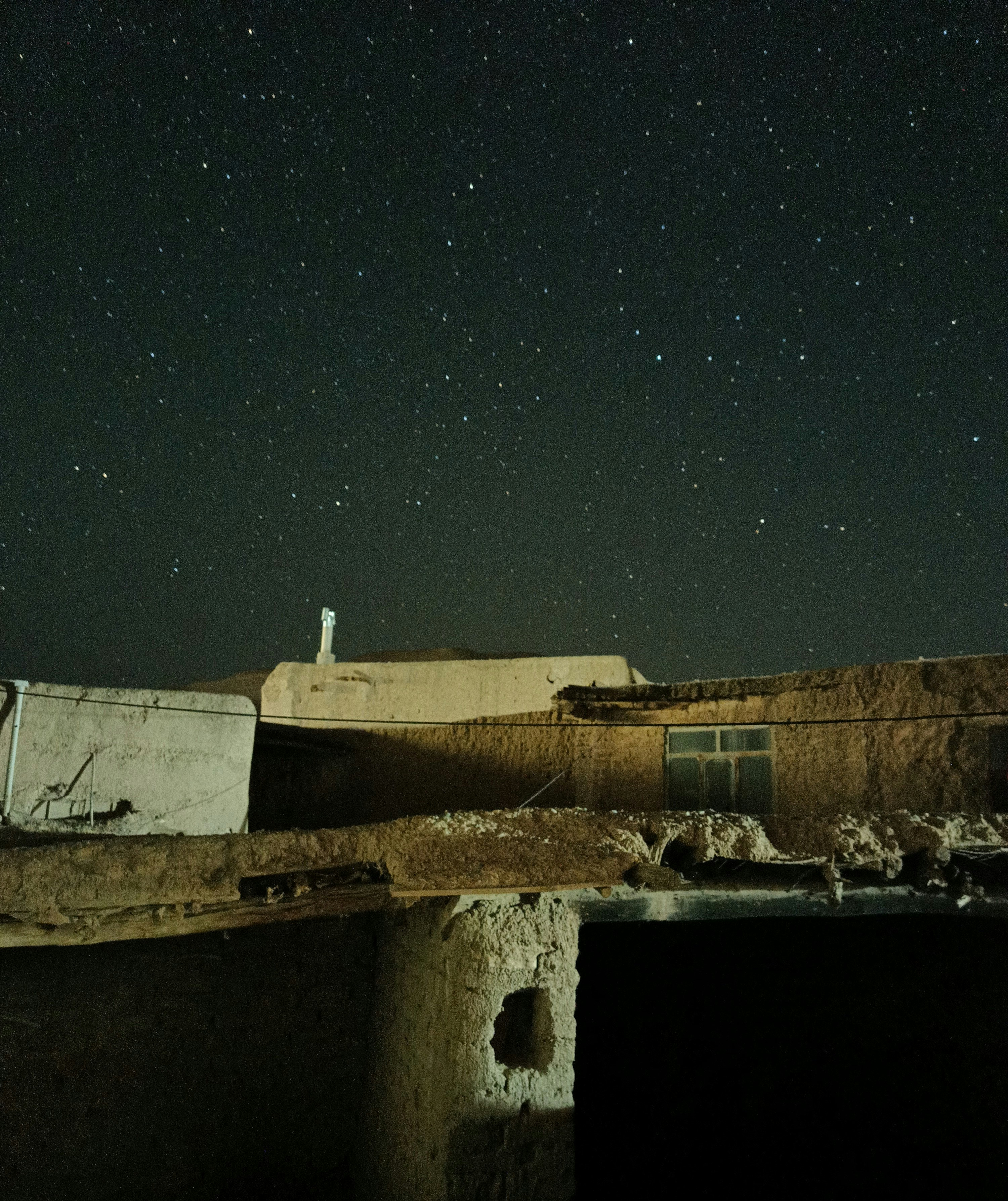 Starry Veil Above Weathered Adobe Rooftops