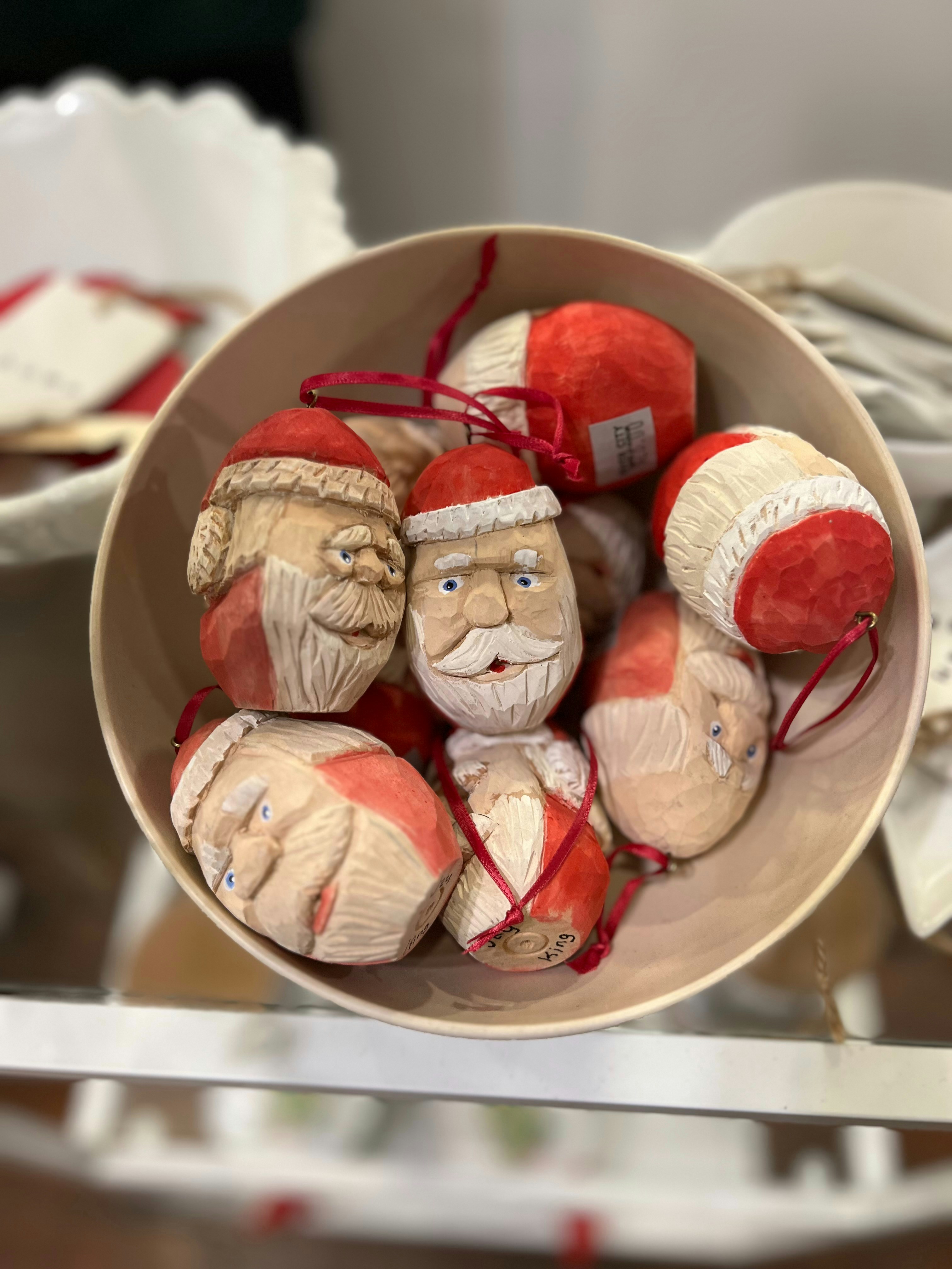 Santa Faces Nestled in a Cream Bowl: A Cluster of Hand-Carved Ornaments