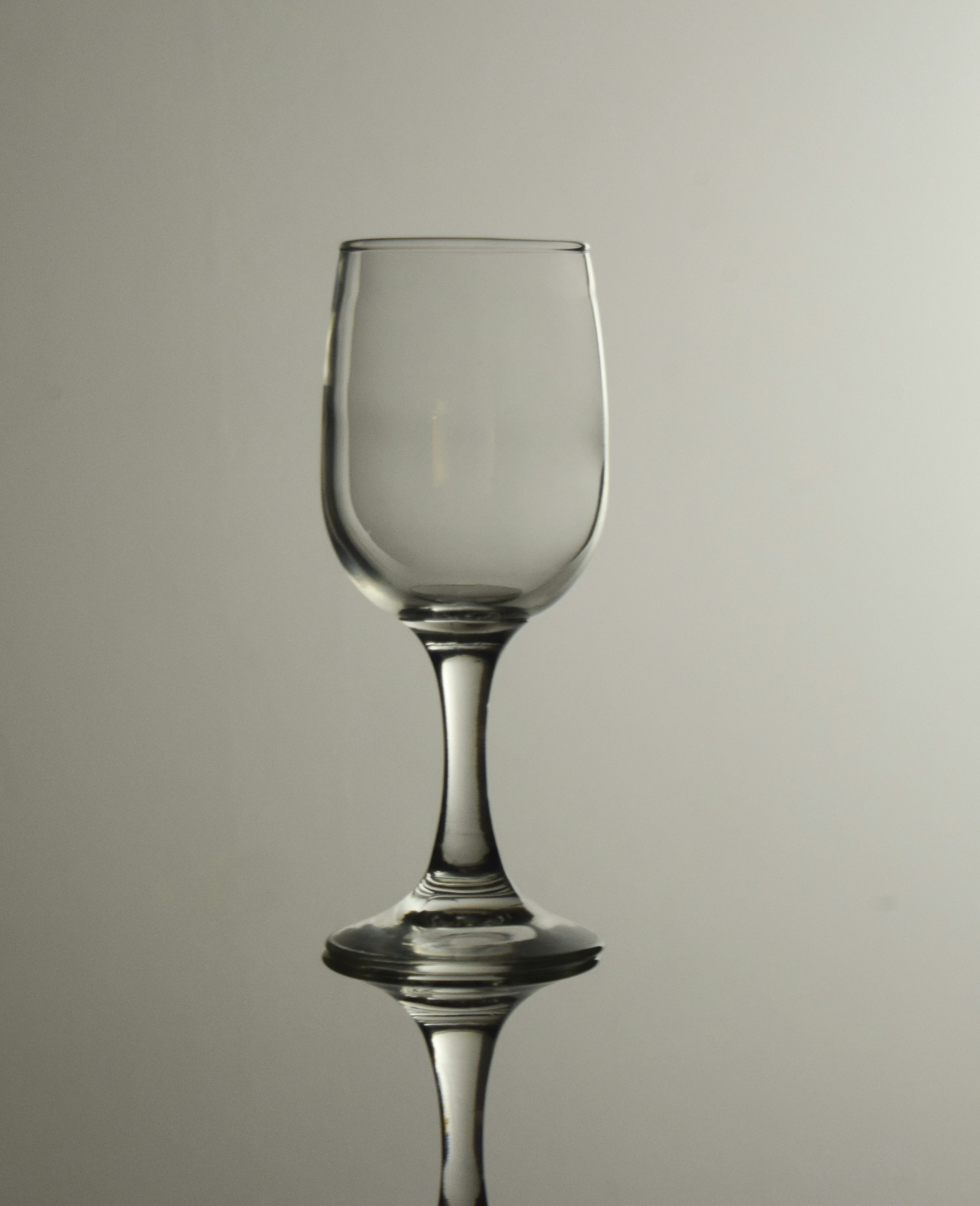 Wine glass with reflection | a wine glass sitting on top of a table
