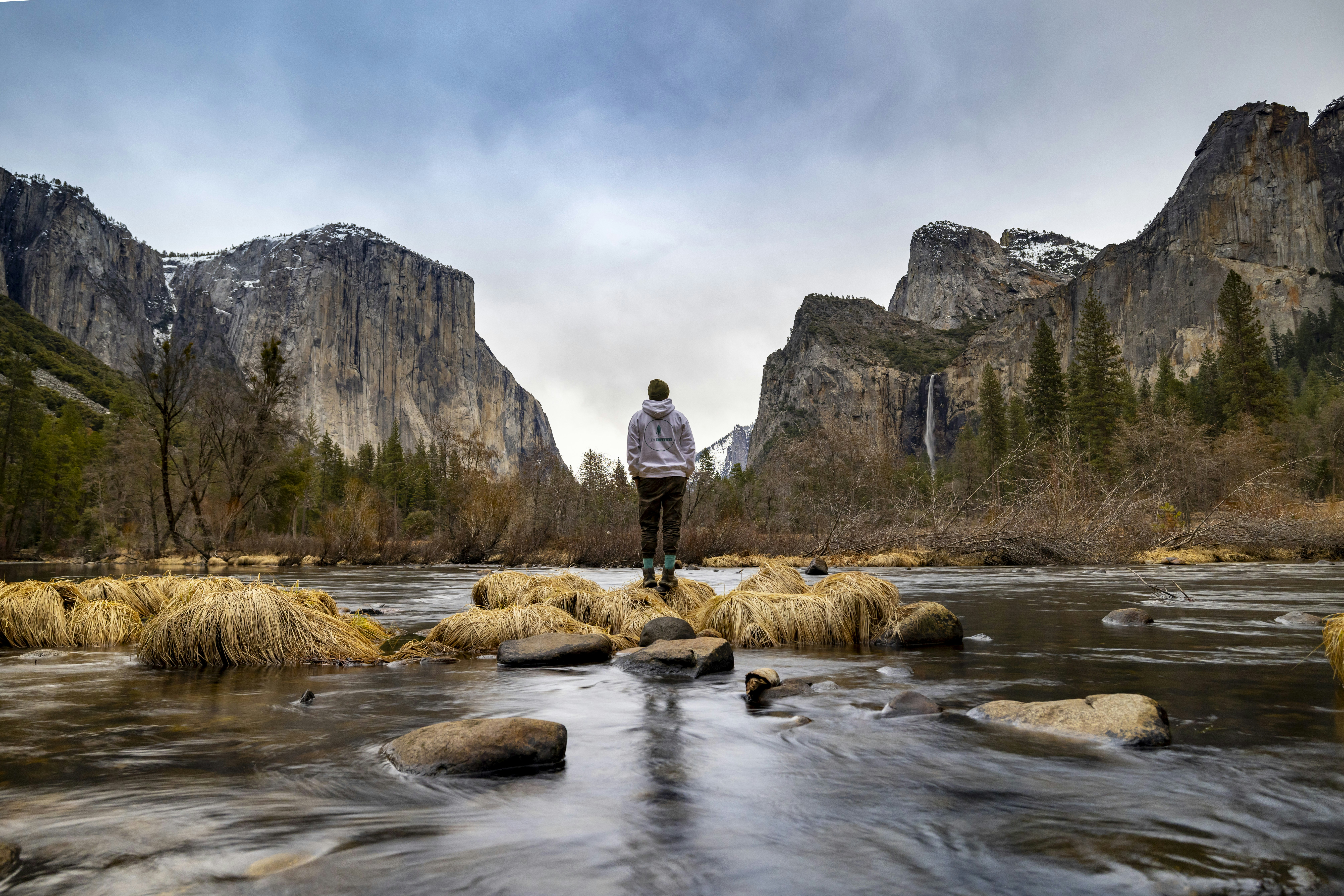 A man standing on a rock in the middle of a river photo – Free Tunnel view Image on Unsplash