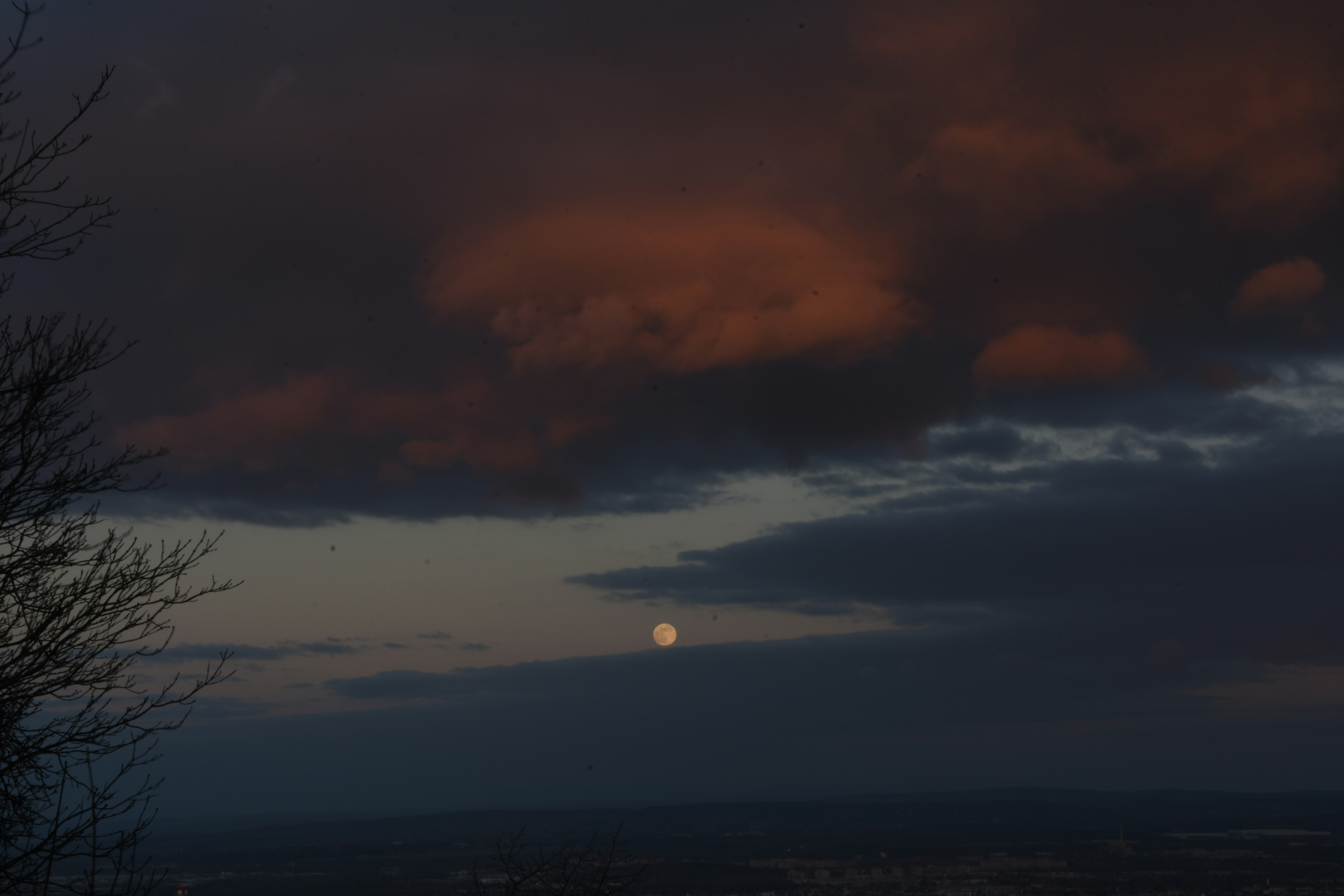 Moonlight among Ember Clouds: A Quiet Dusk Over the Horizon