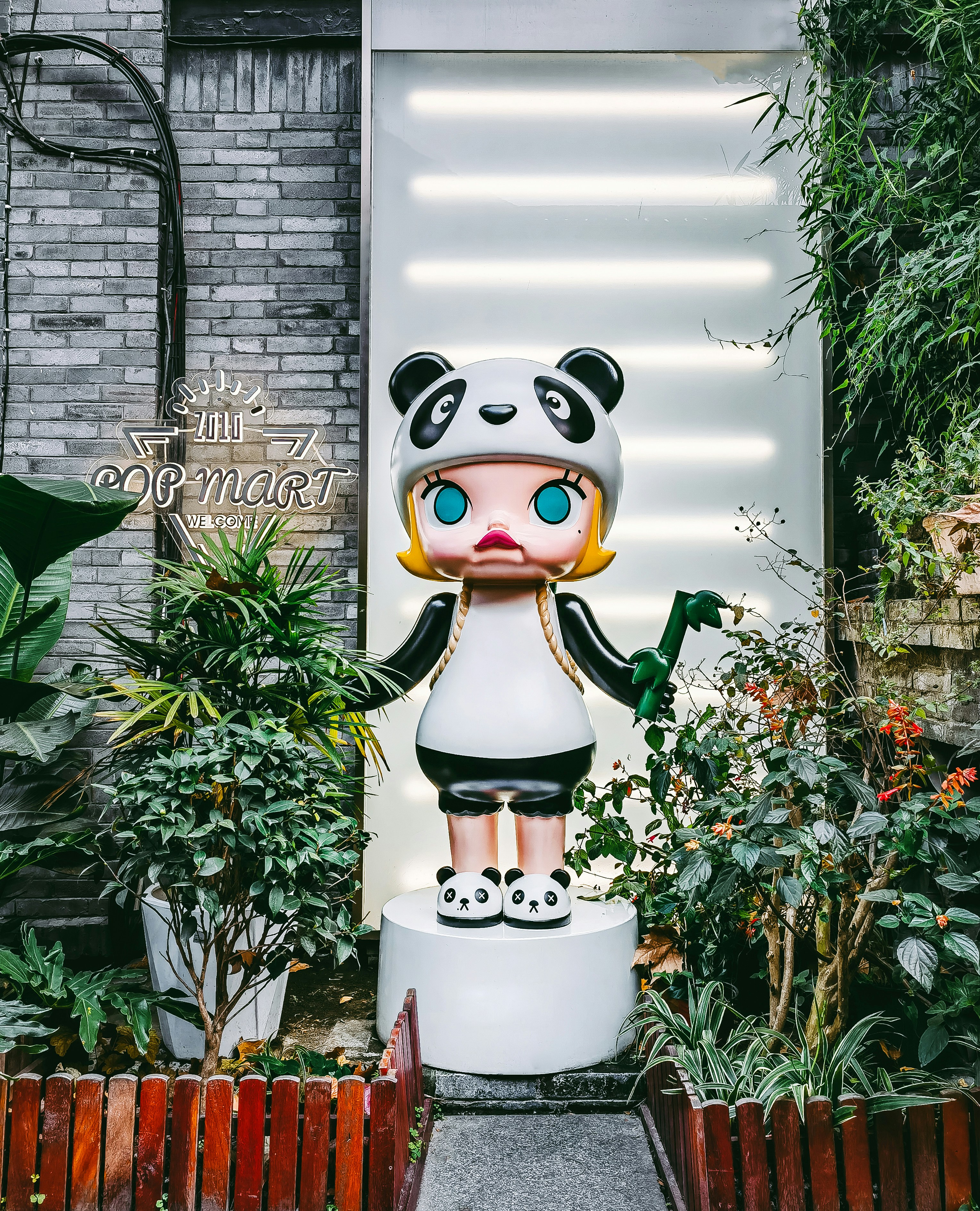 Panda-Hued Mascot Stands Center Stage in Green-Trimmed Courtyard
