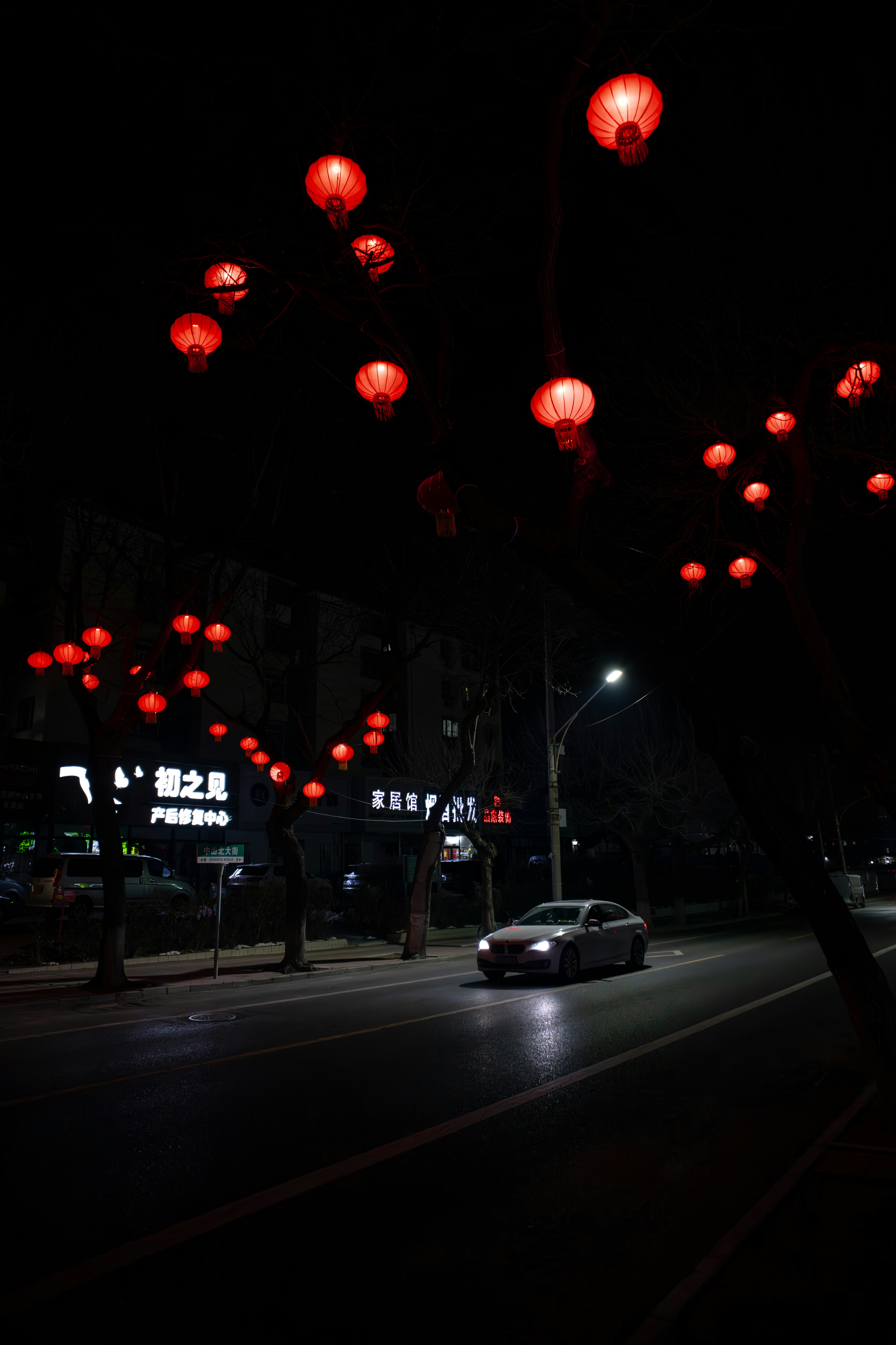 Red Lantern Canopy Over a Midnight Street