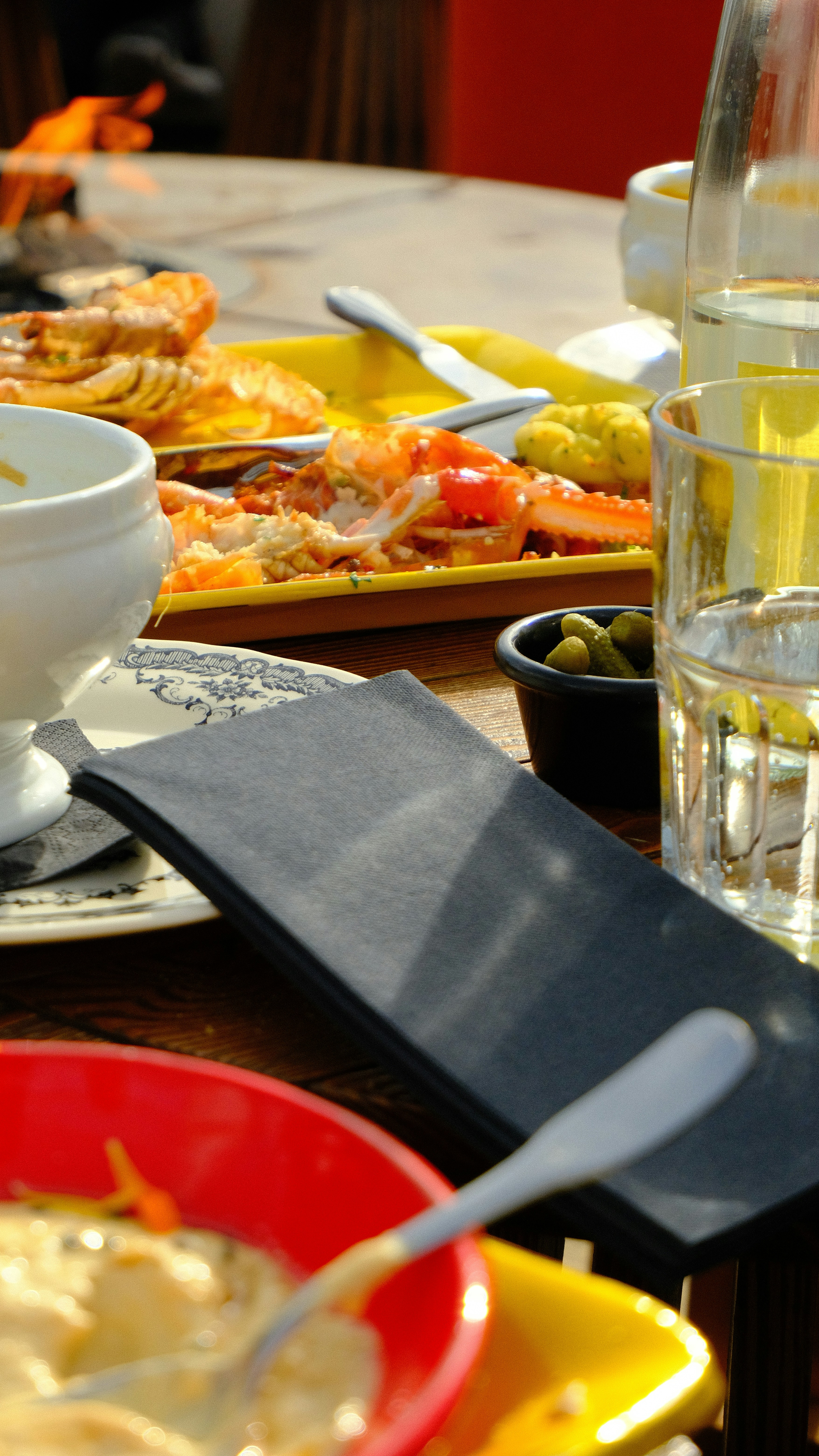Sunlit Seafood Tableau: Lobster and Shrimp on a Bright Yellow Tray