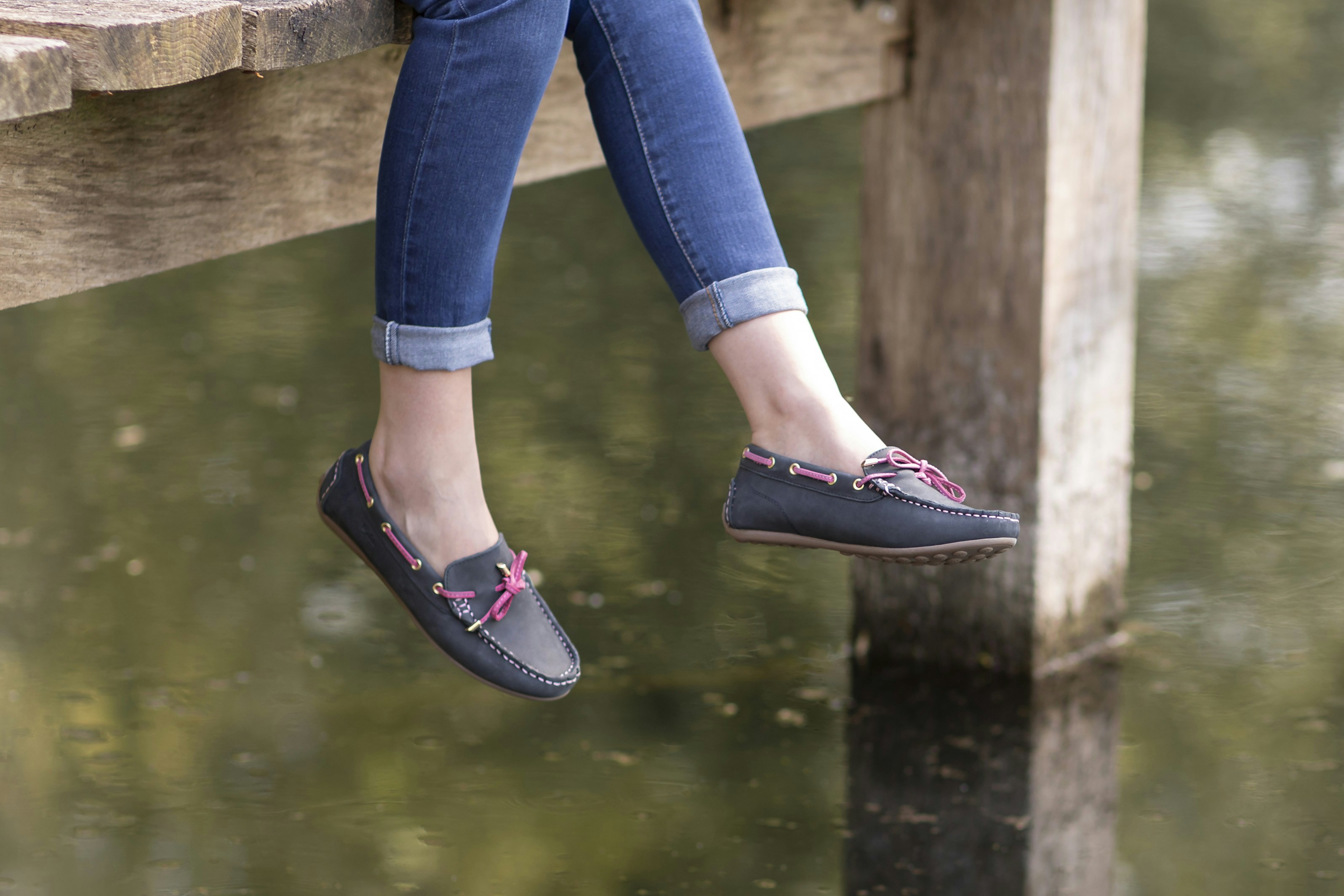 A woman's feet hanging off the edge of a dock photo – Free Ladies ...