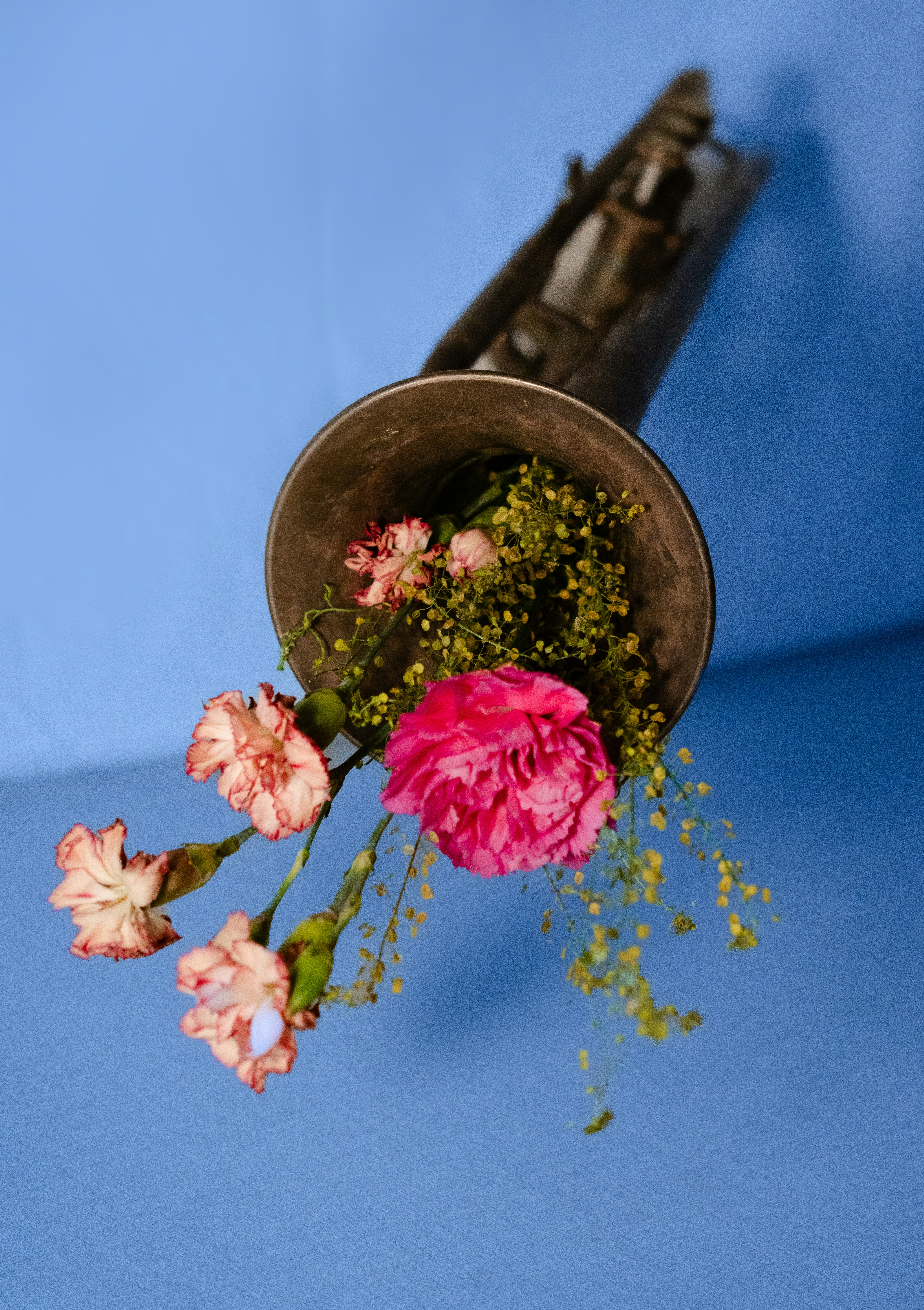 Cobalt Backdrop, Weathered Cup, and Rosy Carnations: A Quiet Still Life