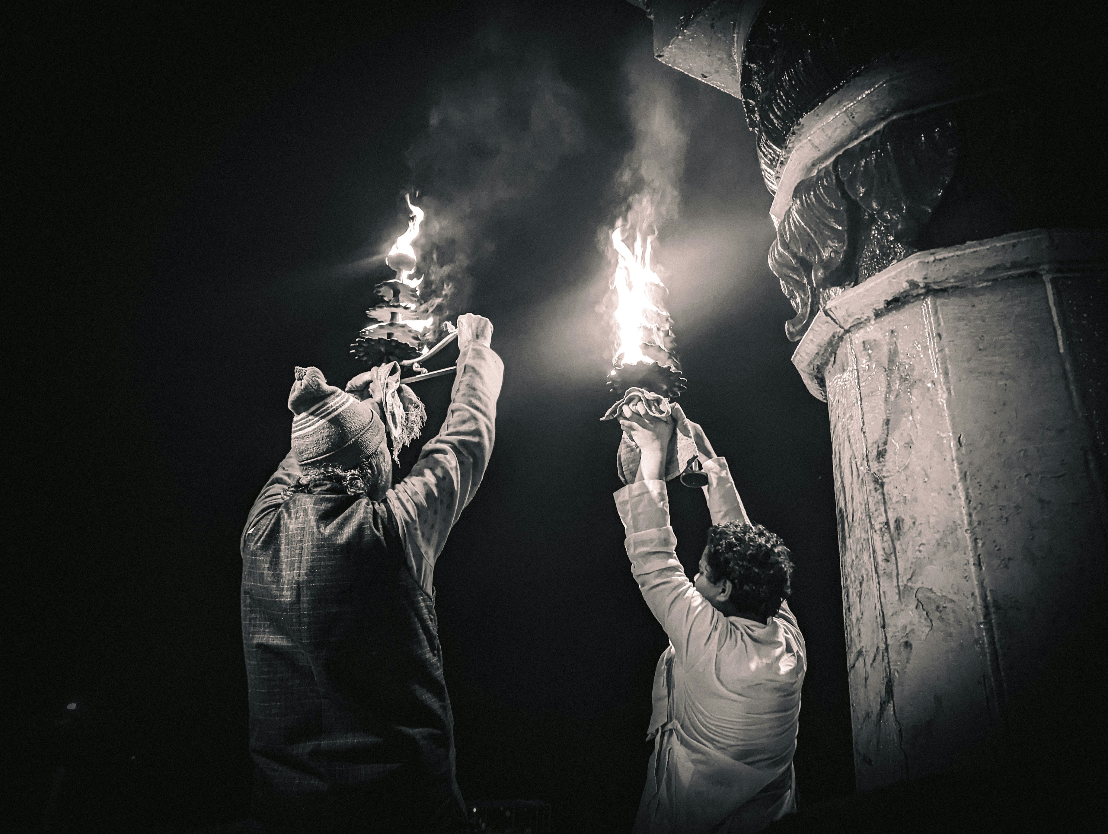 A couple of people holding torches in their hands photo – Free Human ...